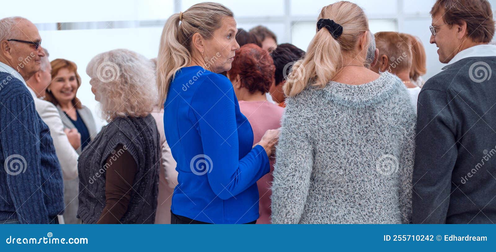 A Group of Old People Standing with Their Backs Indoors Stock Photo ...