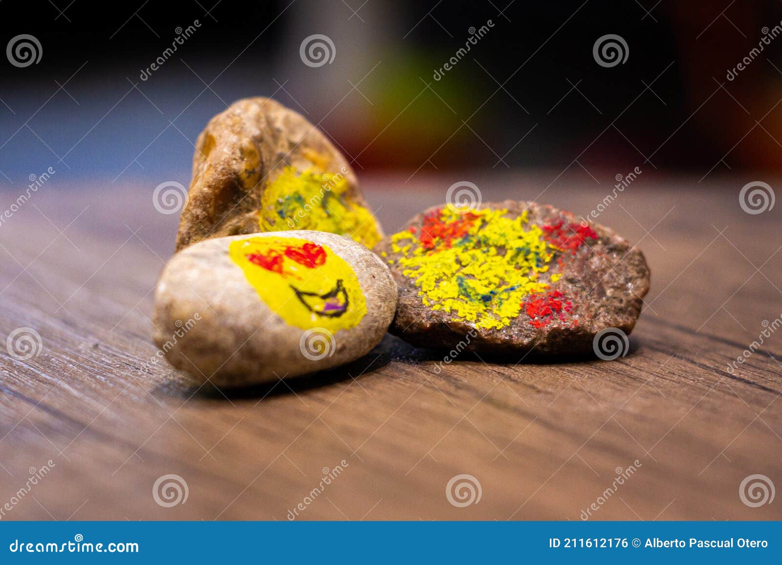 A Group of Painted Pebbles with Emoji Faces on a Table Stock Photo ...