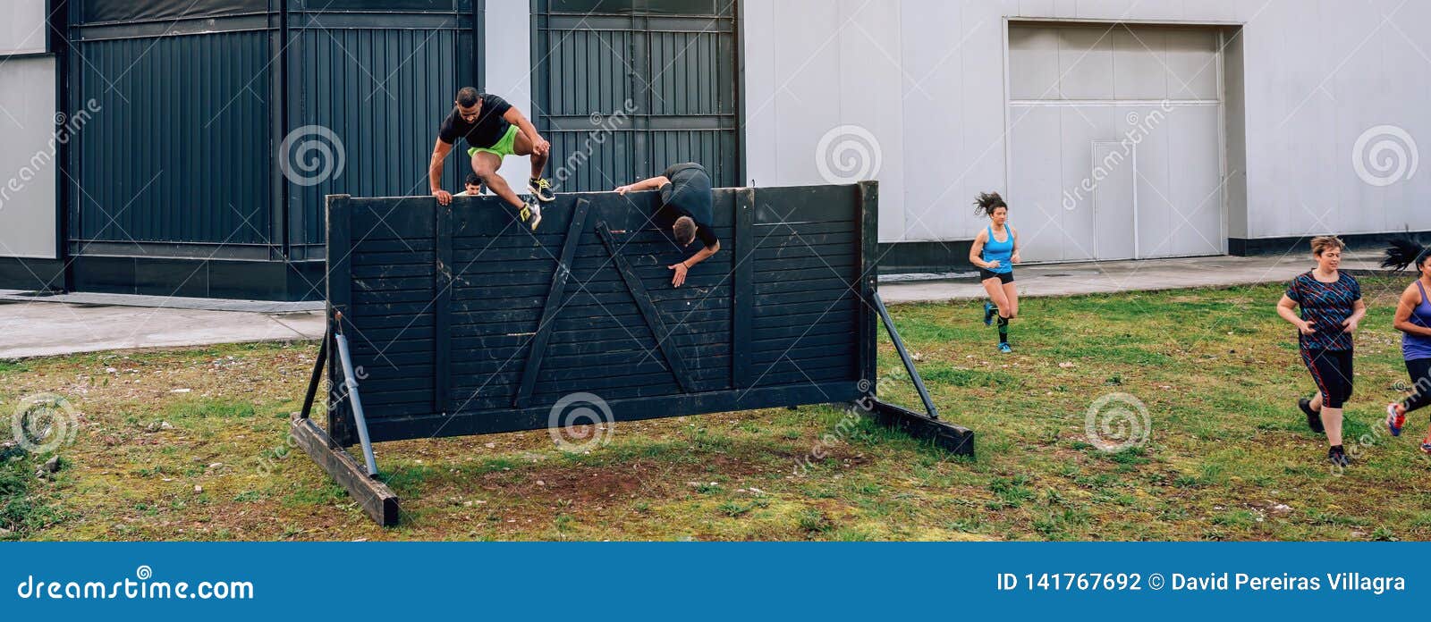 Participants in Obstacle Course Running and Climbing Wall Stock Photo ...