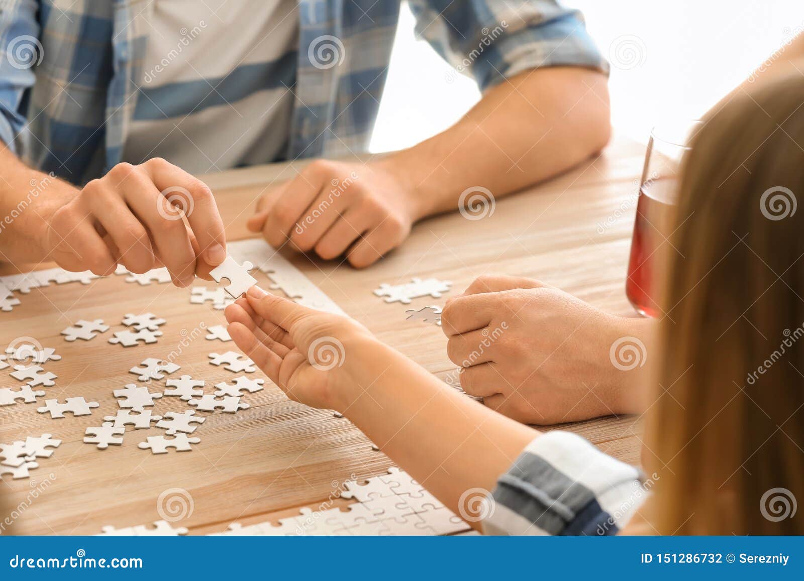Group of People Assembling Puzzle on Wooden Table Stock Photo - Image ...