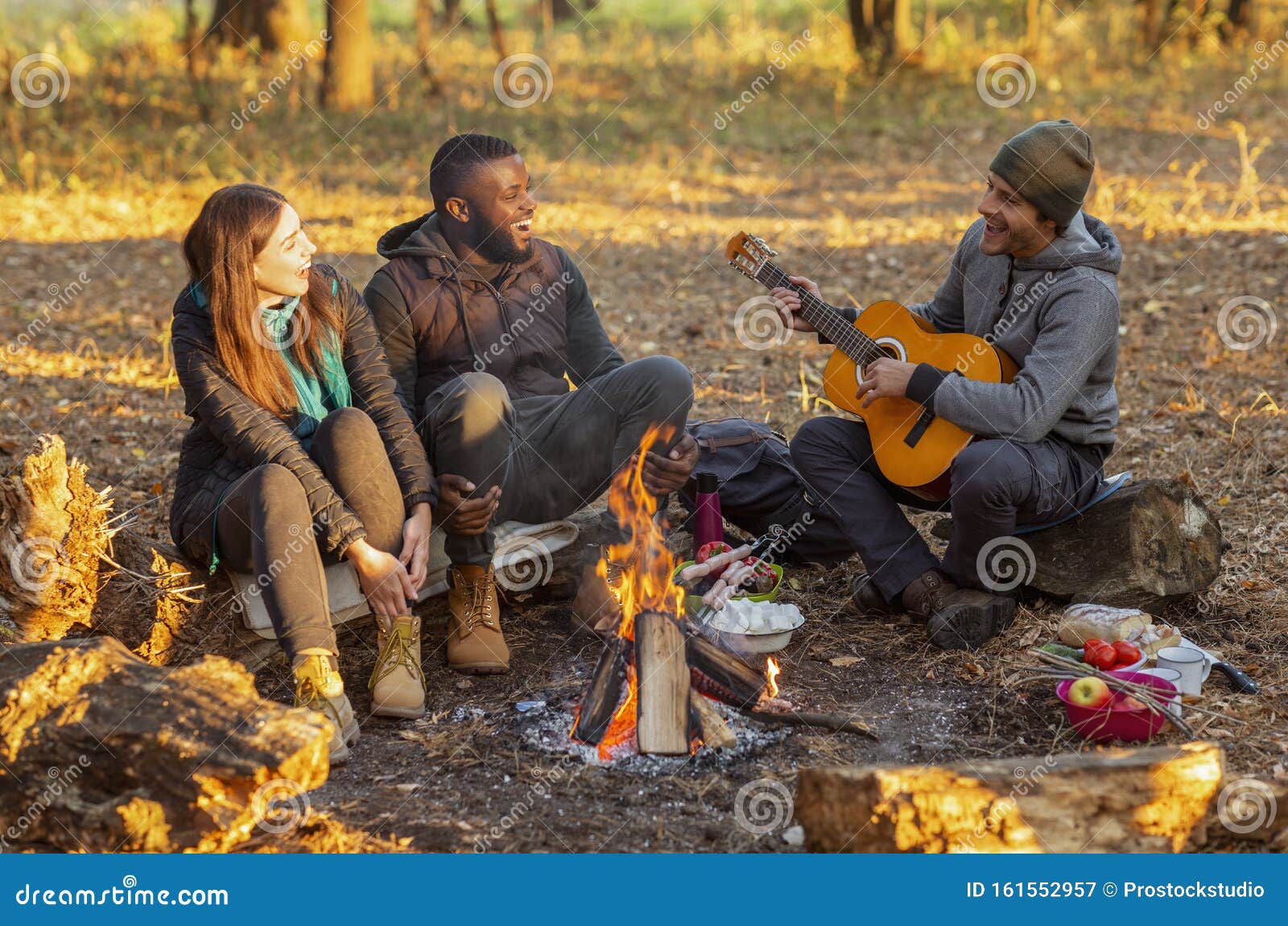 Group of People Camping and Singing in Autumn Woods Stock Image - Image ...