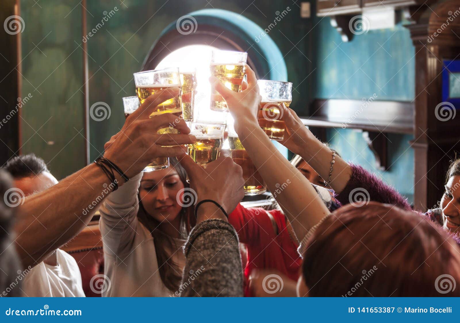 Group of People Celebrating in a Pub Drinking Beer Stock Image - Image ...