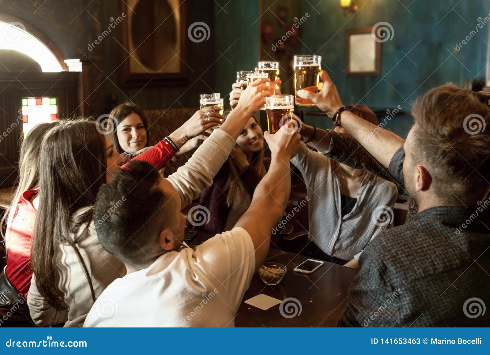 Group of People Celebrating in a Pub Drinking Beer Stock Image - Image ...