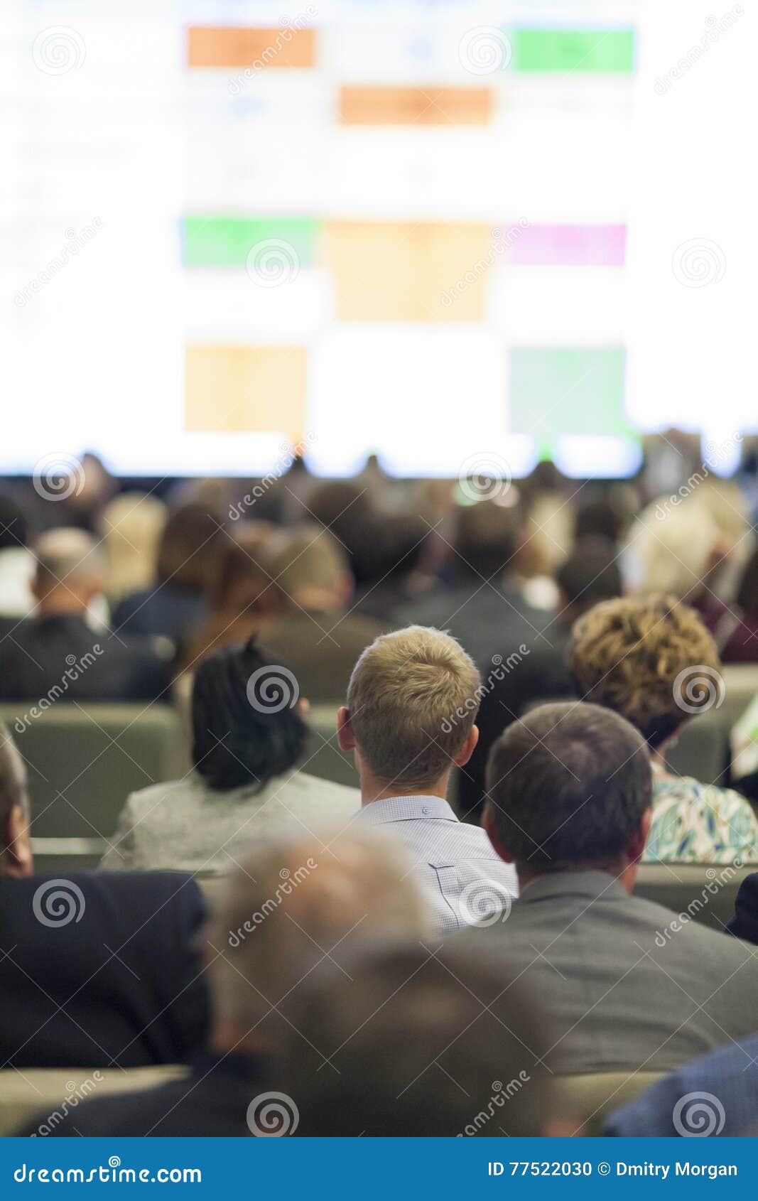 Group of People at the Conference Watching Presentation Charts ...