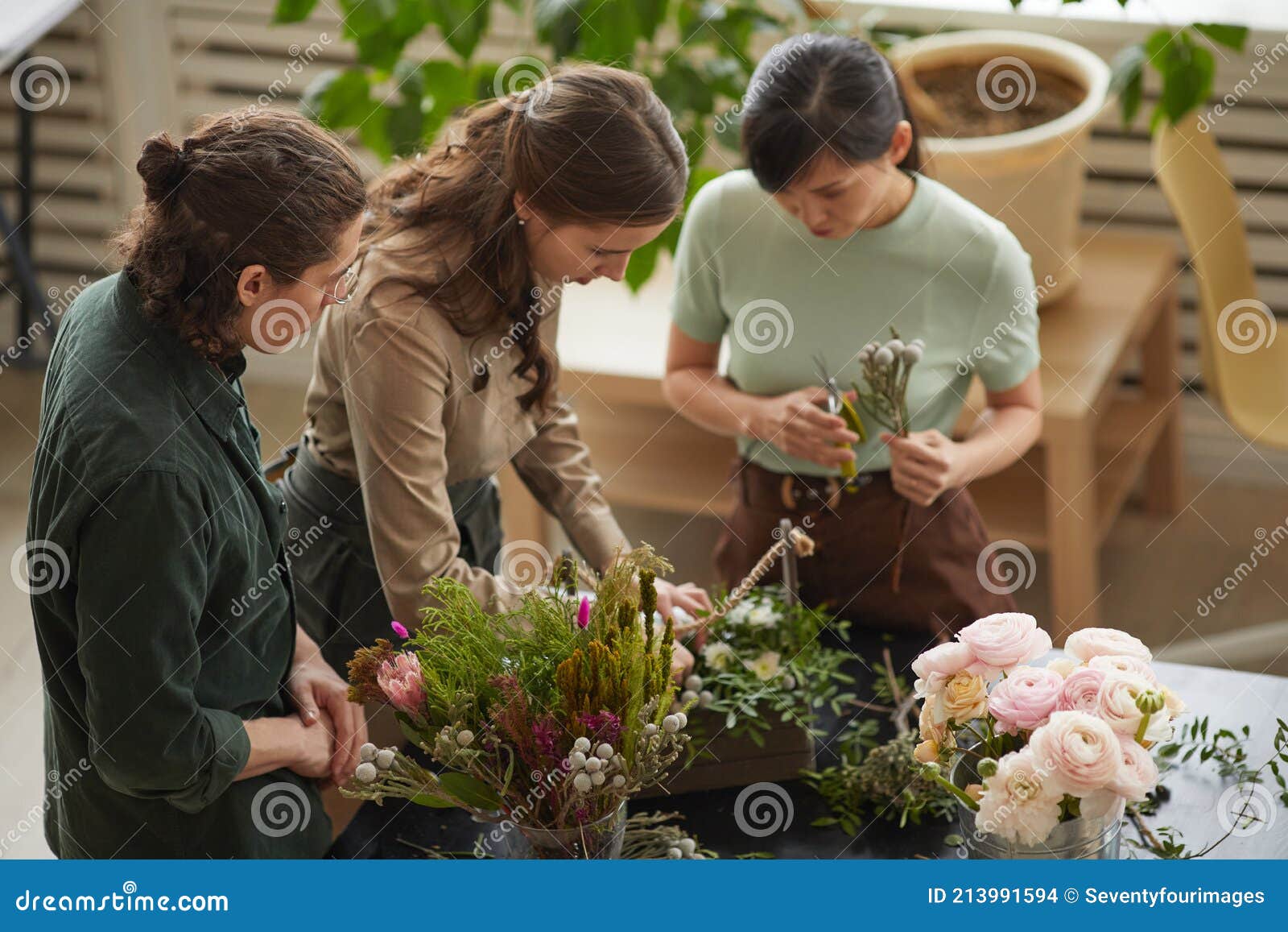 Group of People Creating Flower Compositions in Workshop Stock Photo ...
