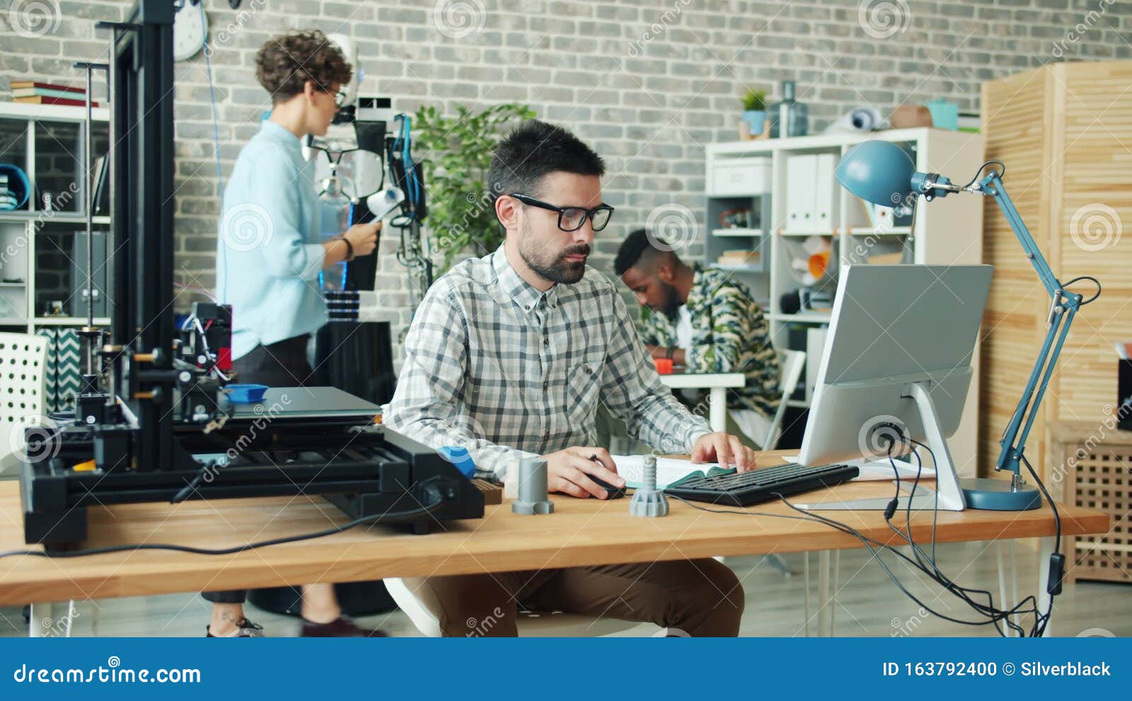 Group of People Designing Robot in Office Using 3d Printer and Computer ...