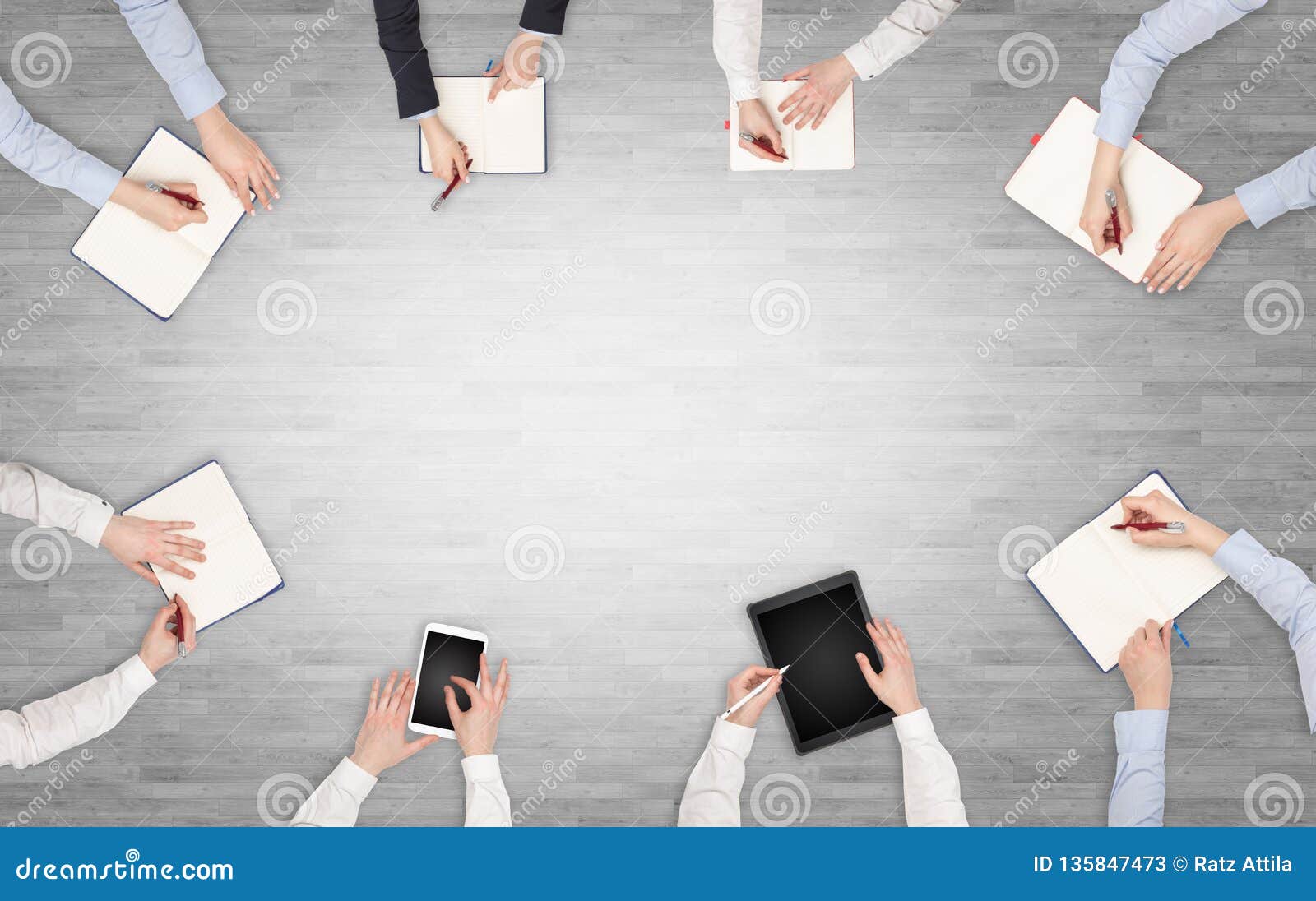 Group of People with Devices in Hands Having Desk Discussion and ...