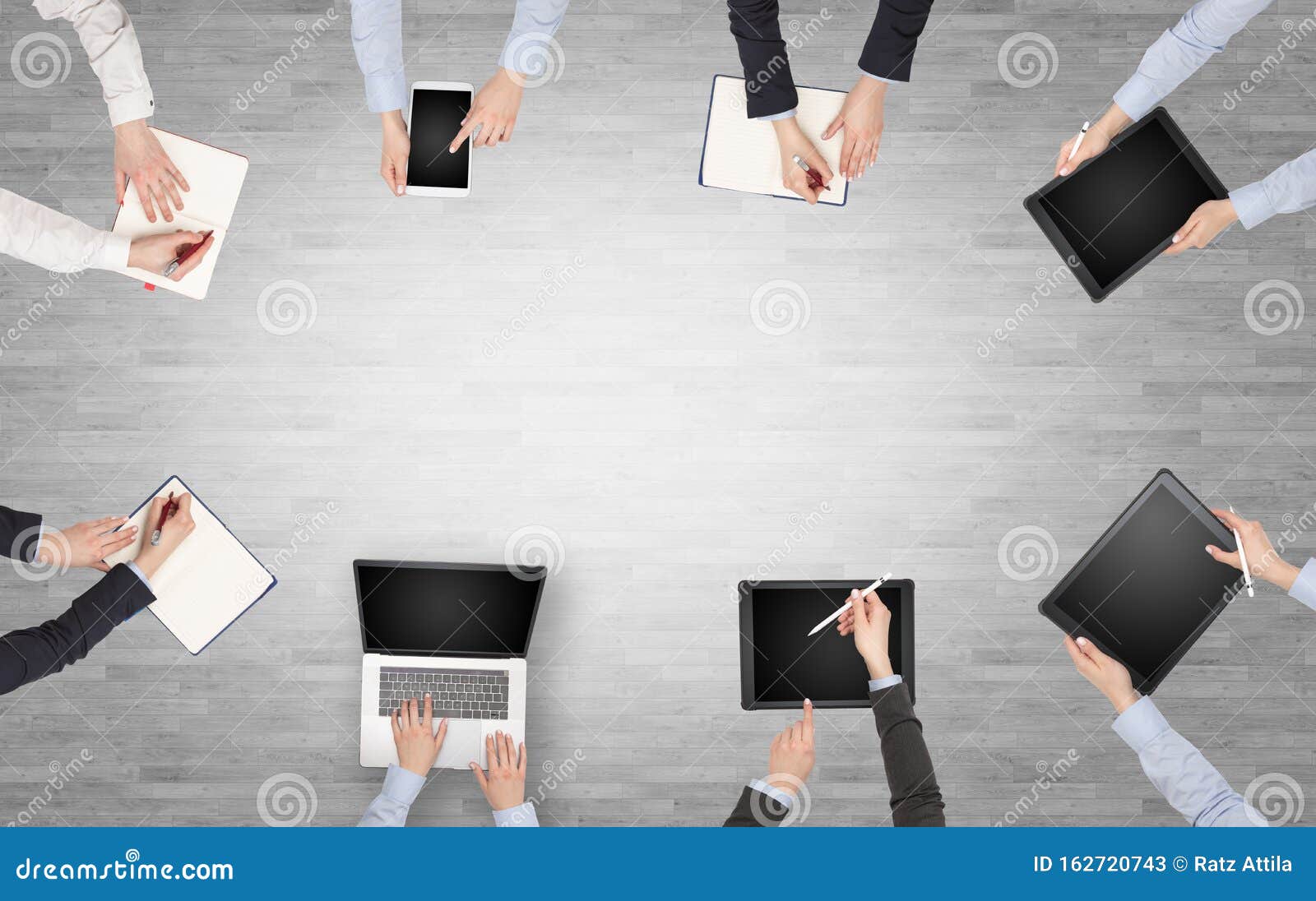 Group of People with Devices in Hands Having Desk Discussion and ...