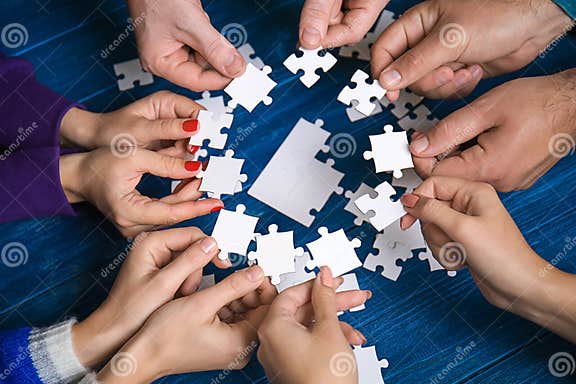 Group of People Doing Puzzle on Table Stock Photo - Image of game ...