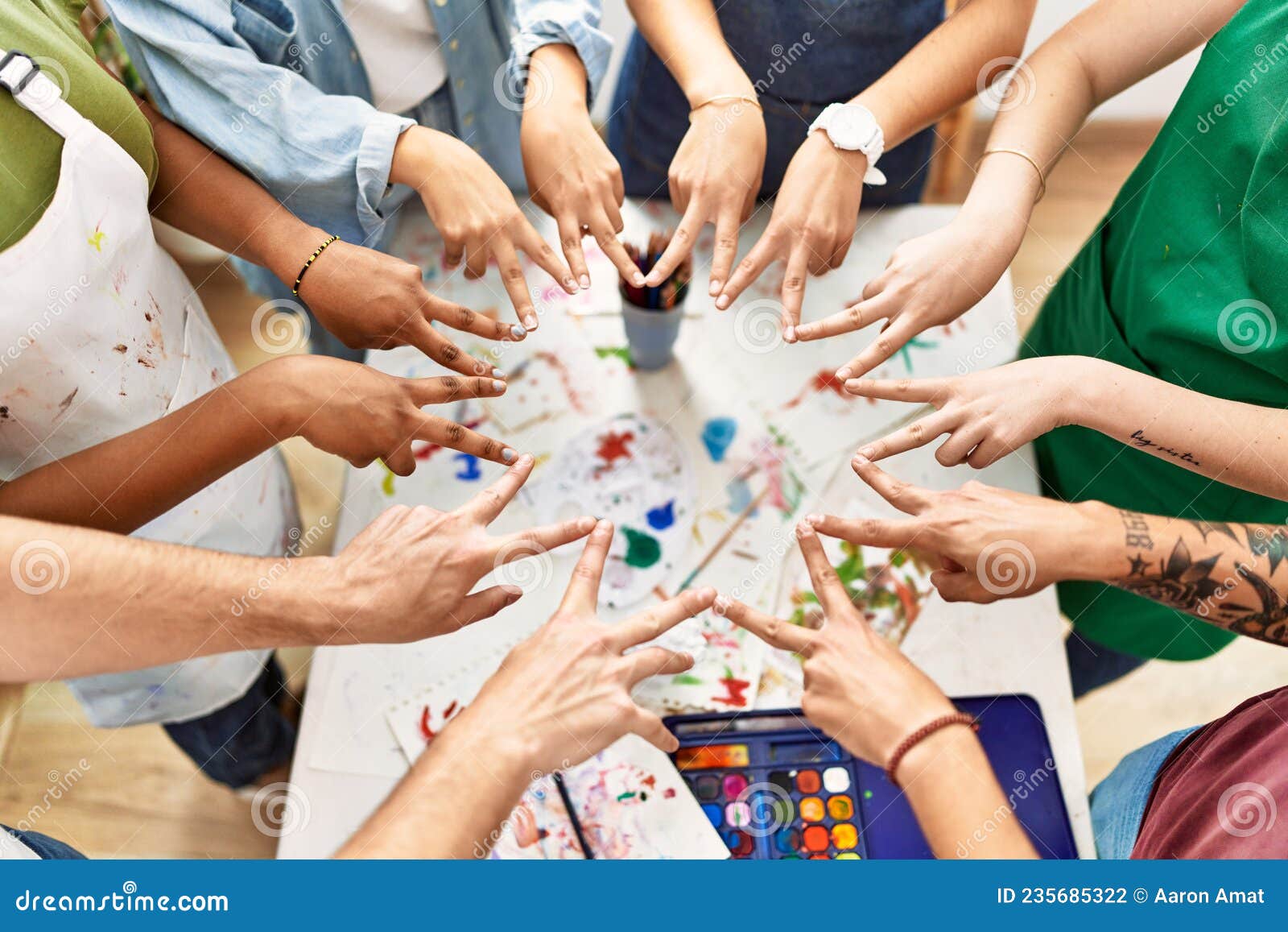 Group of People Doing Victory Sign with Fingers Together at Art Studio ...