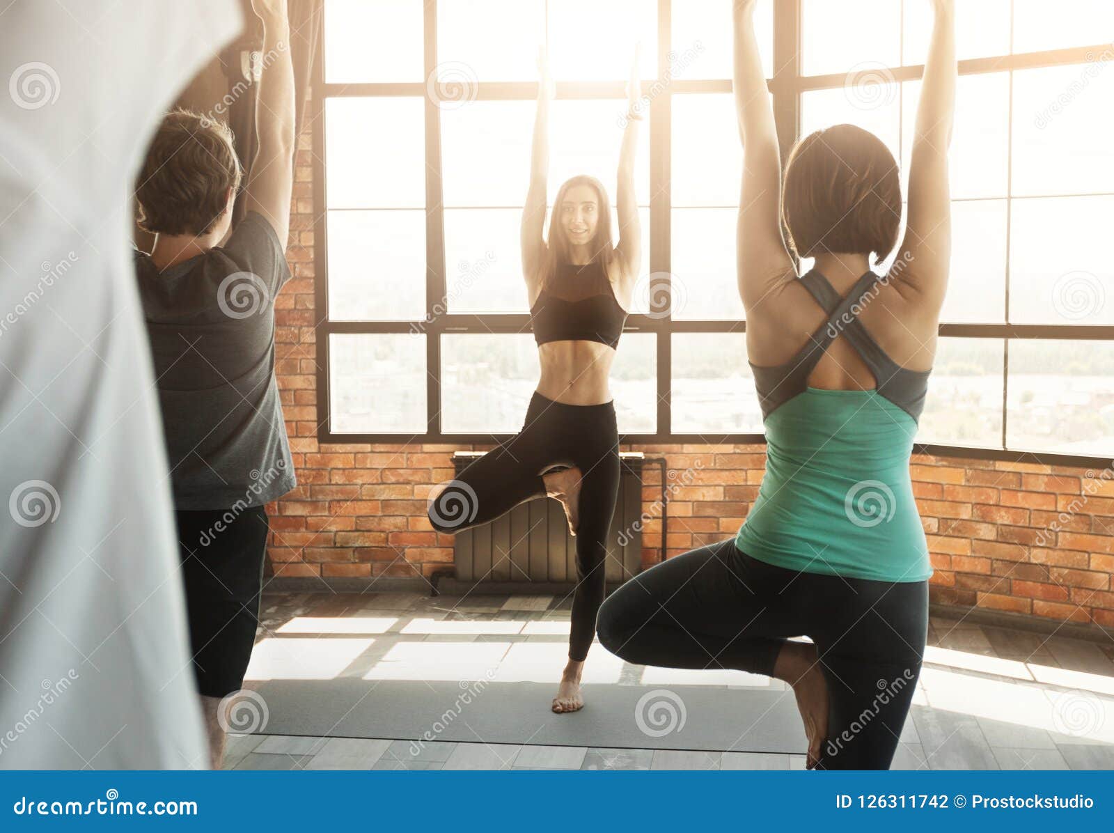 Group of People Doing Yoga in Tree Pose at Studio Stock Photo - Image ...