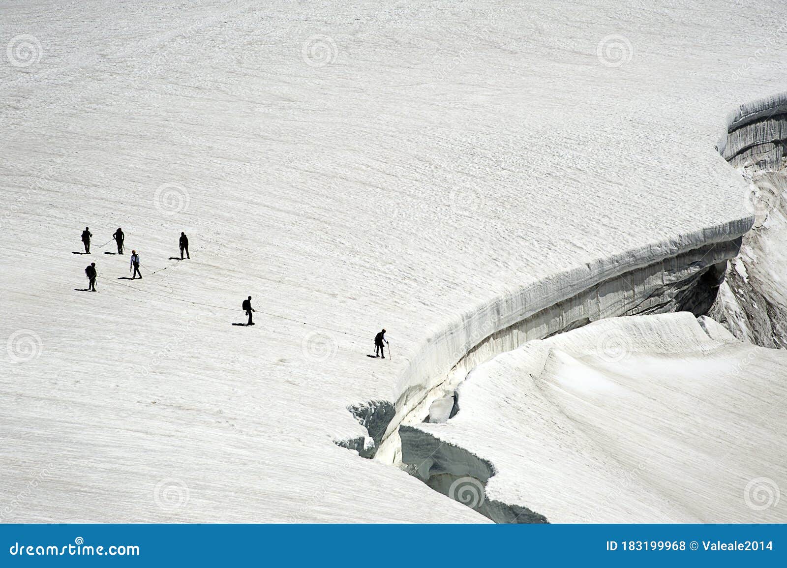A Group of People Exploring a Crevasse in a Glacier Stock Photo - Image ...