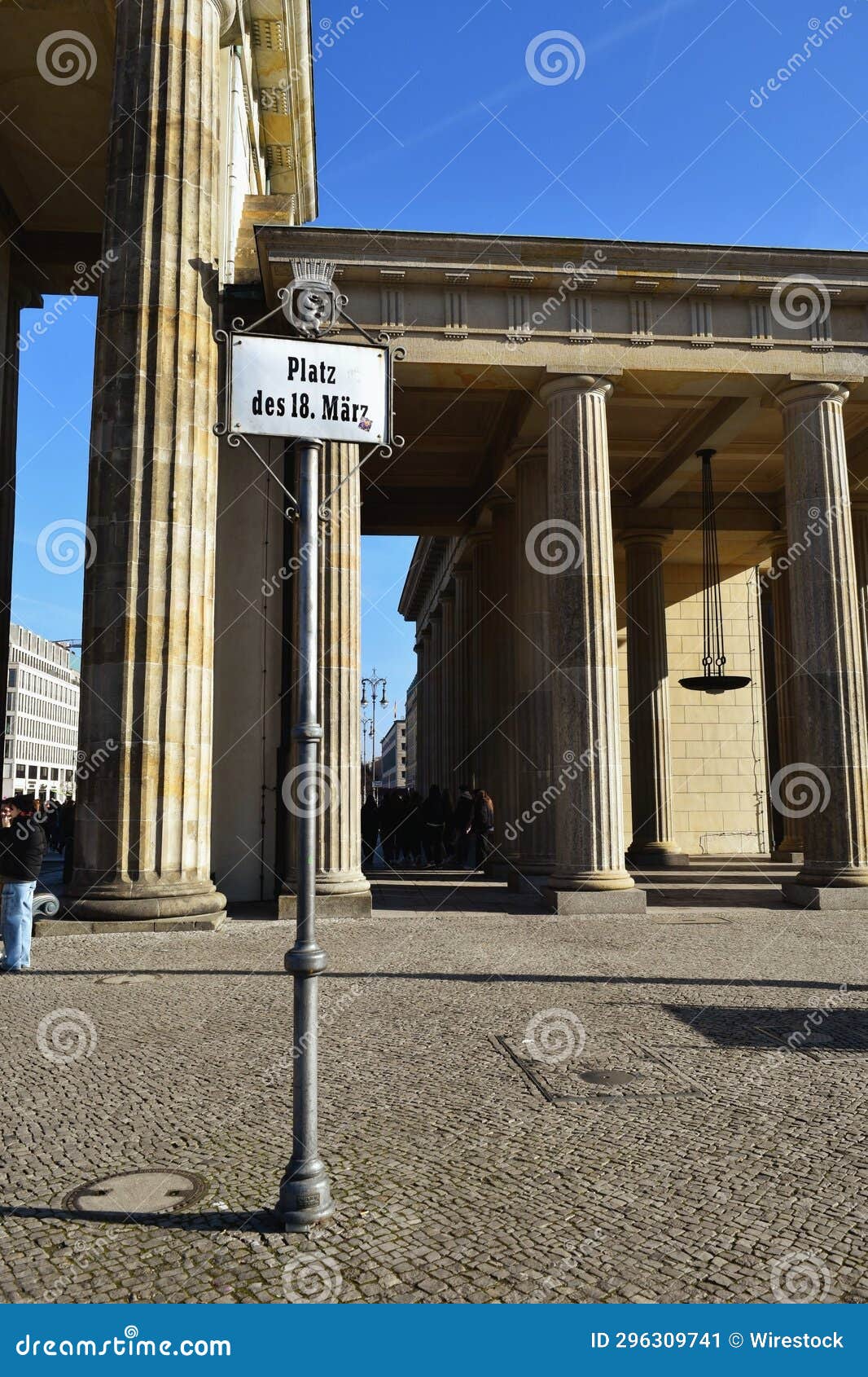 Group of People in Front of a Street Sign, Indicating a Direction in ...