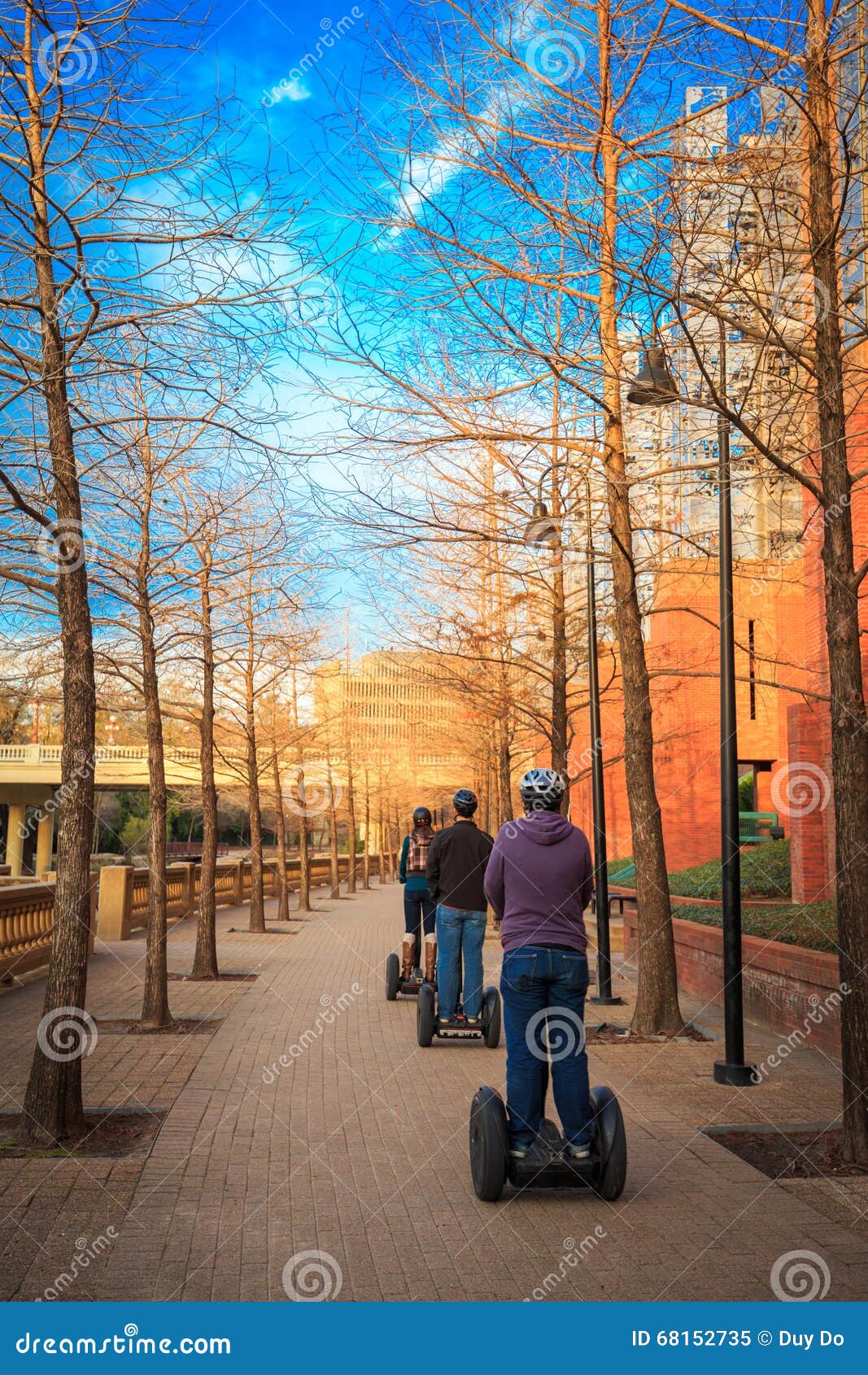 A Group of People Go on the Same Way, on Two Wheel Electric Devi ...