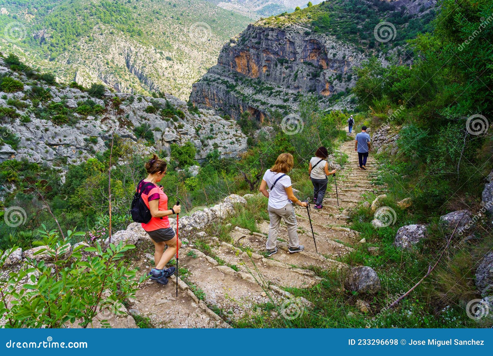 Group of People Hiking on the Mountain Path Going Down Step Stock Photo ...