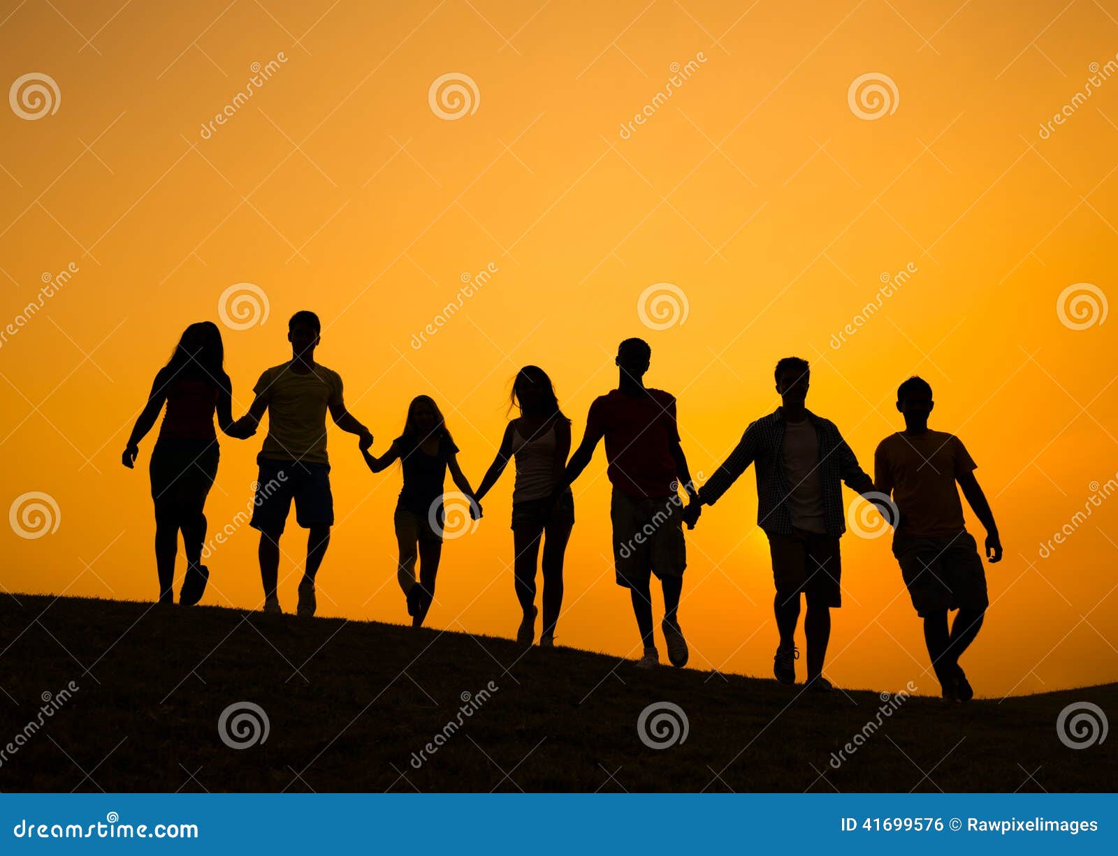 Group of People Holding Hands in Back Lit Stock Photo - Image of people ...