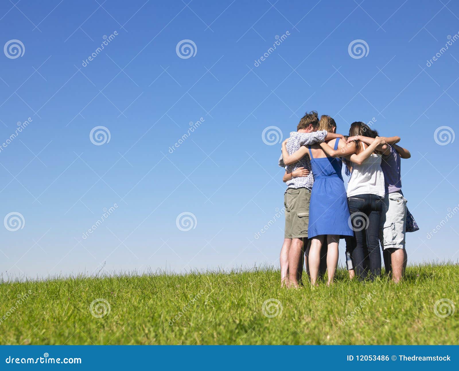 Group of People in Huddle in Field Stock Photo - Image of blond, male ...