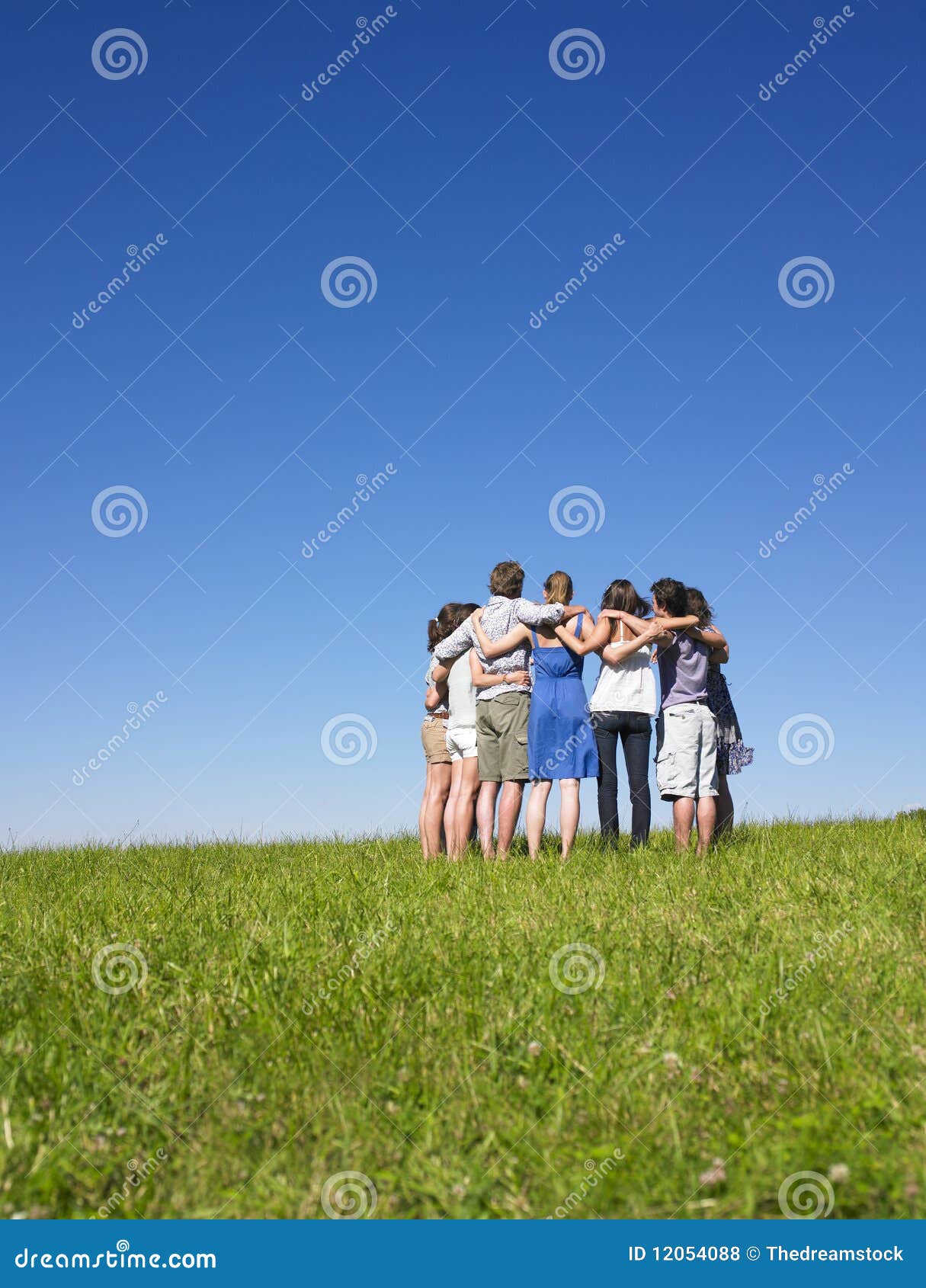 Group of People in Huddle in Field Stock Photo - Image of away ...