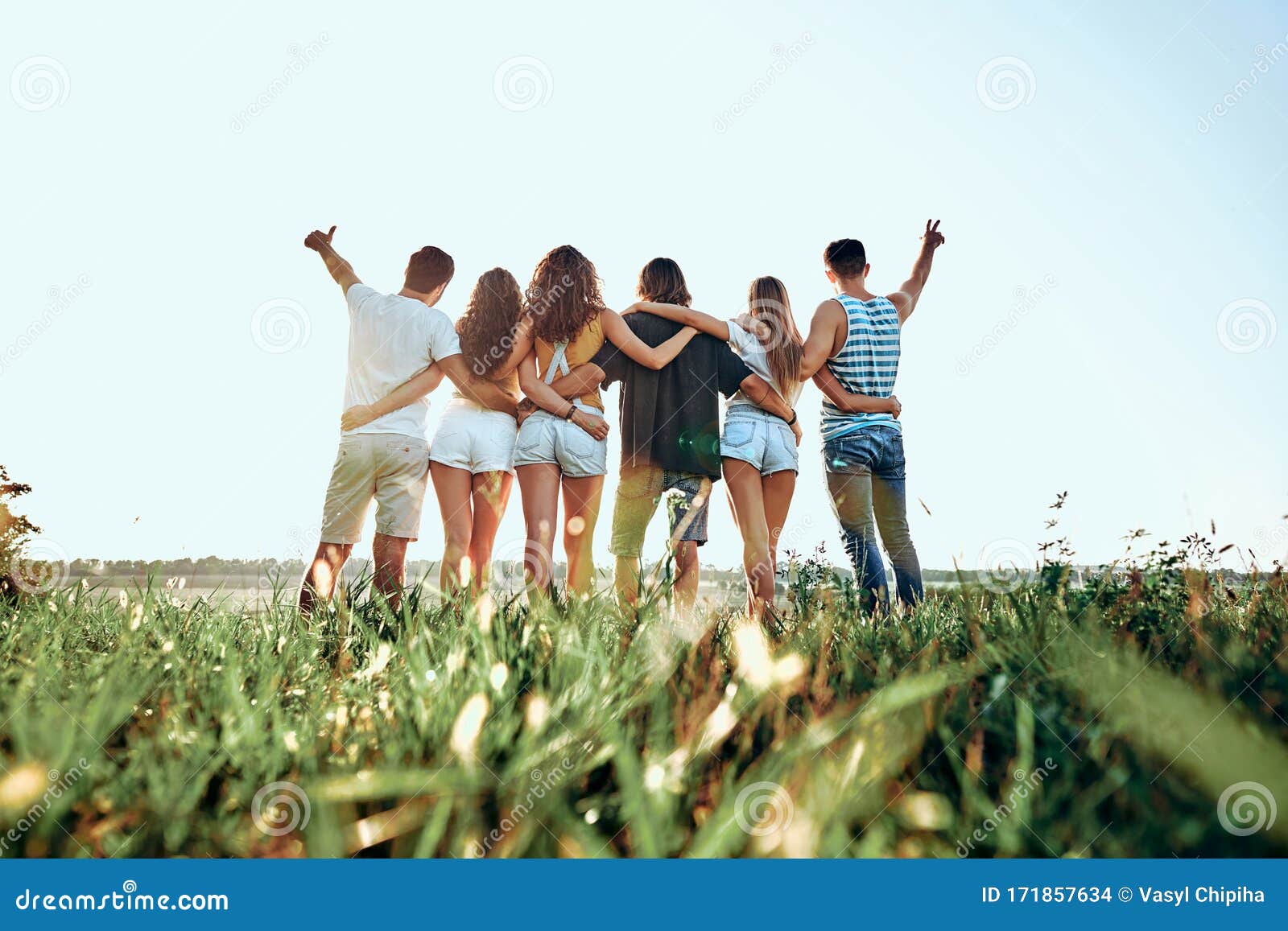 A Group of People Huddle in a Field Stock Photo - Image of outside ...