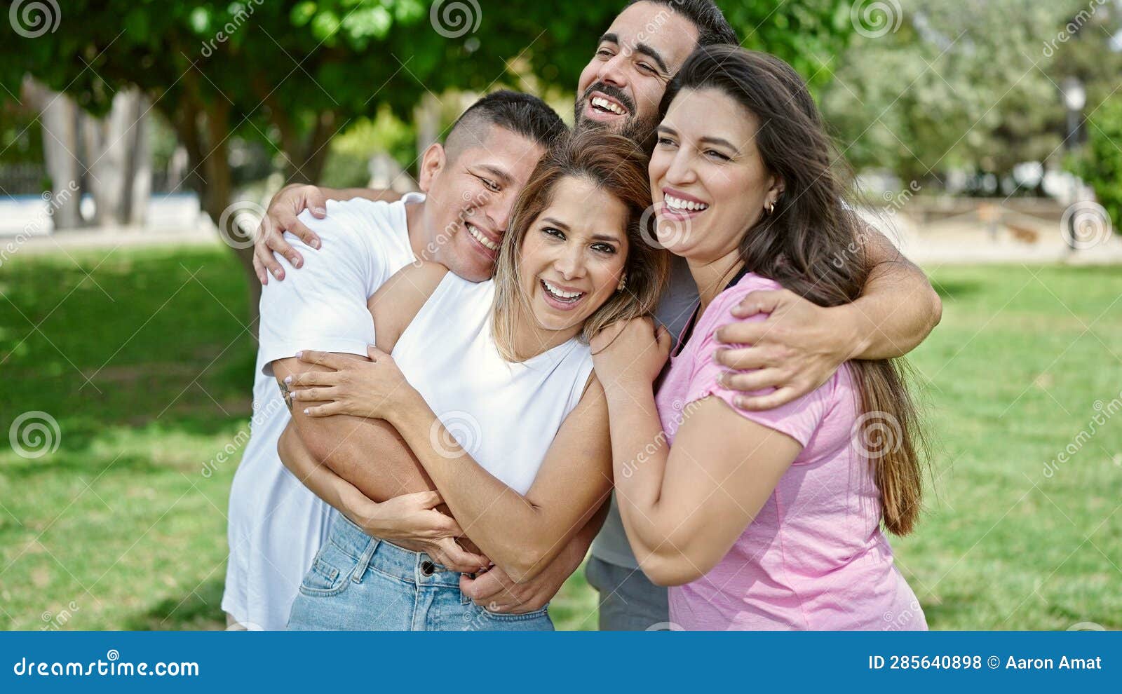 Group of People Hugging Each Other Smiling at Park Stock Photo - Image ...