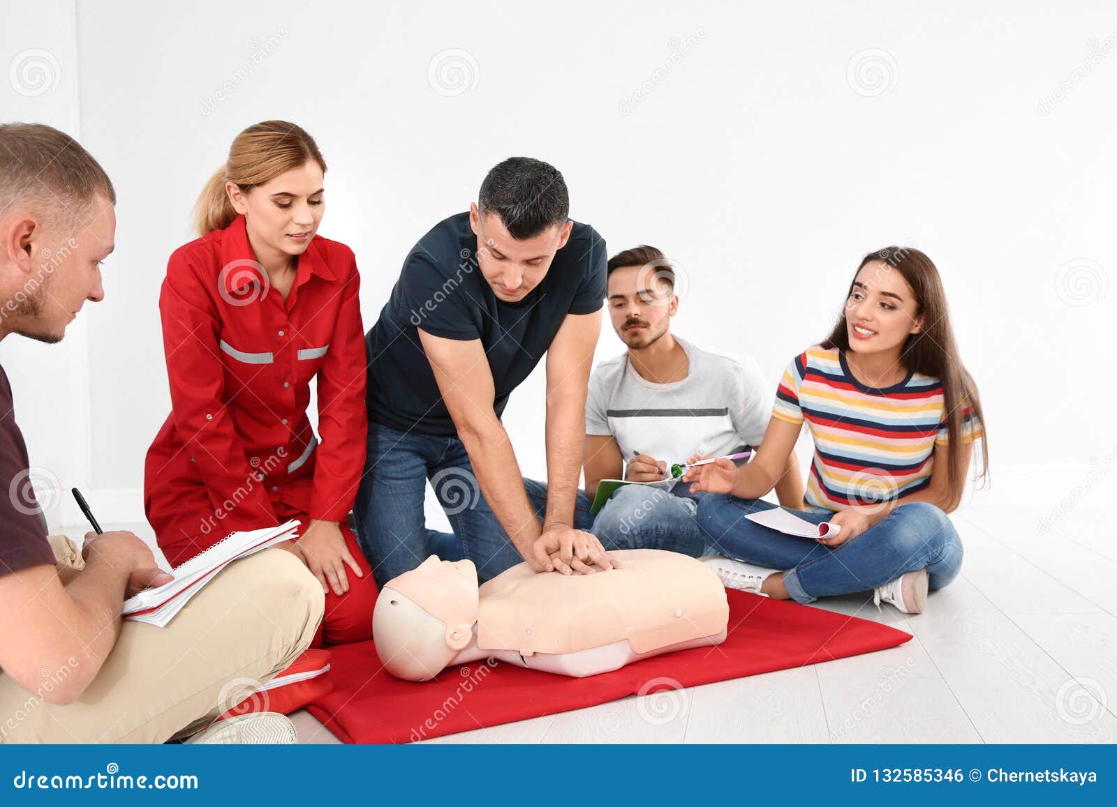 Group of People with Instructor Practicing CPR on Mannequin at First ...