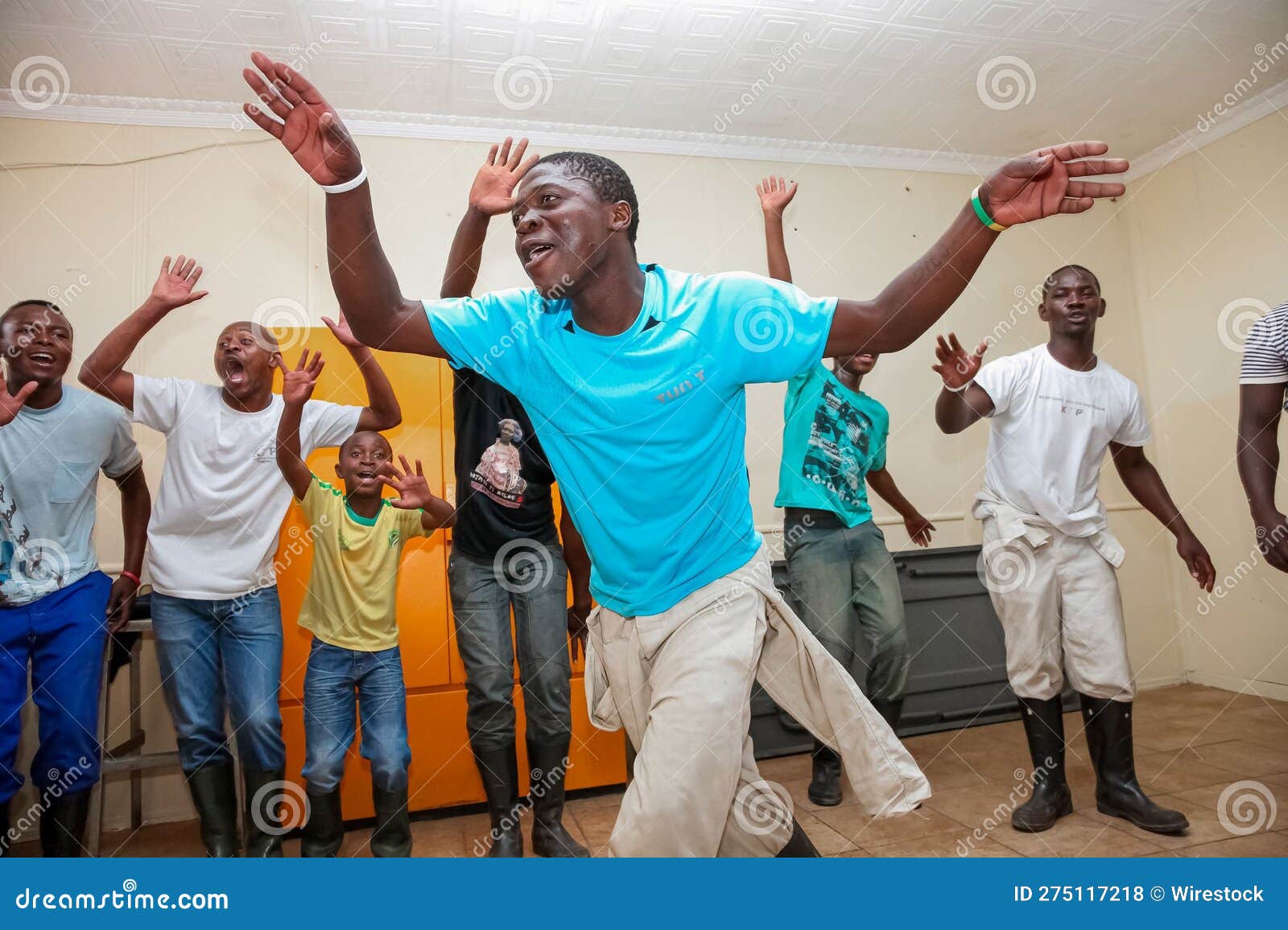 Group of People Joyously Dancing in a Circle, with Their Hands Raised ...