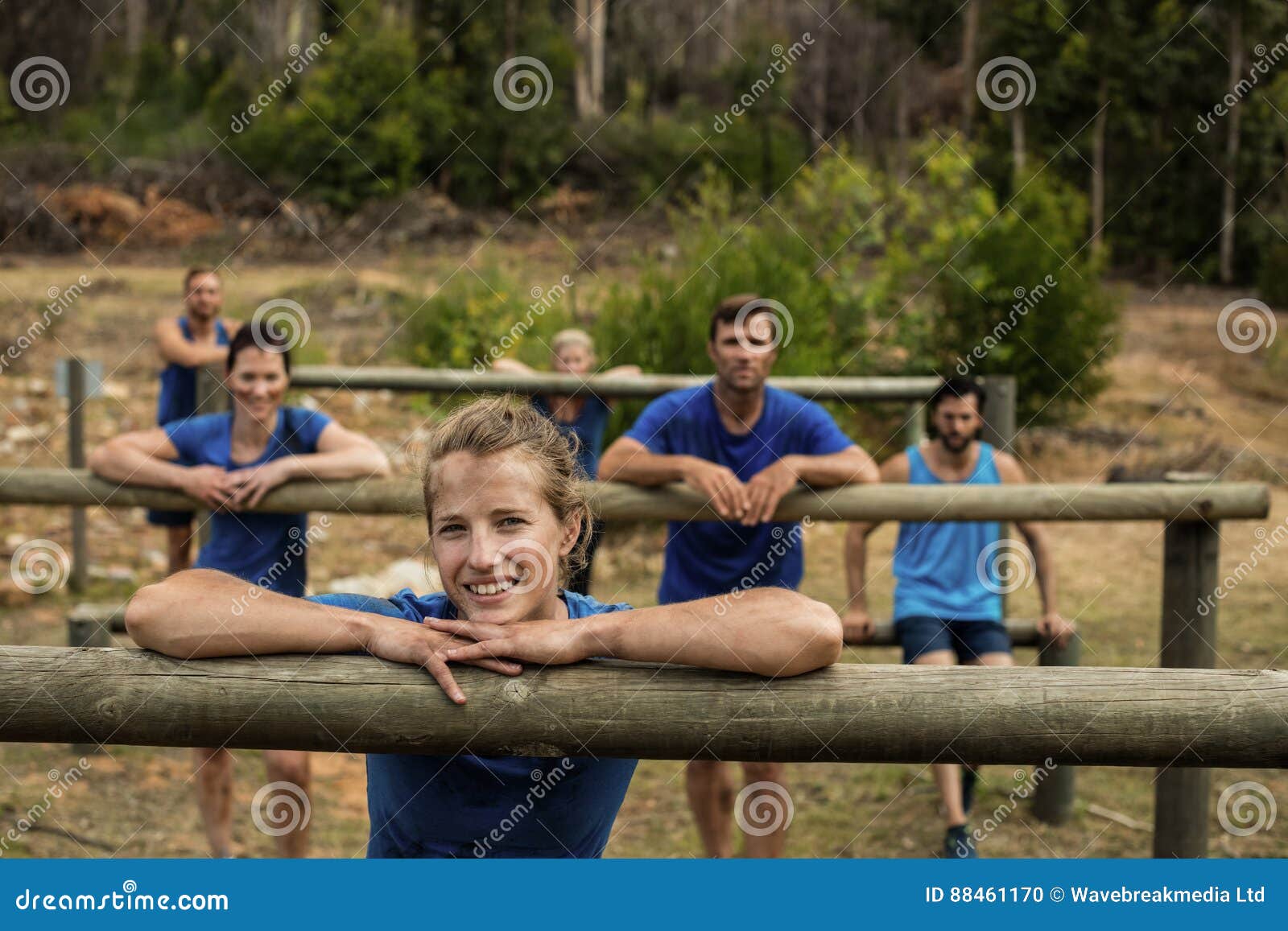 Group of People Leaning on Hurdles during Obstacle Training Stock Photo ...