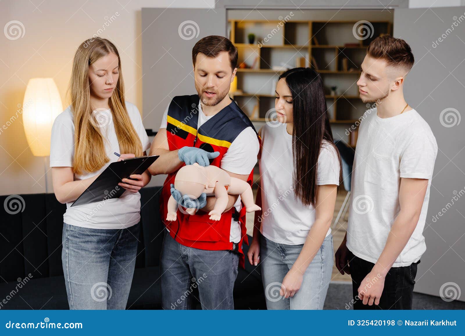 Group of People Learning How To Make First Aid with Dummy Child during ...