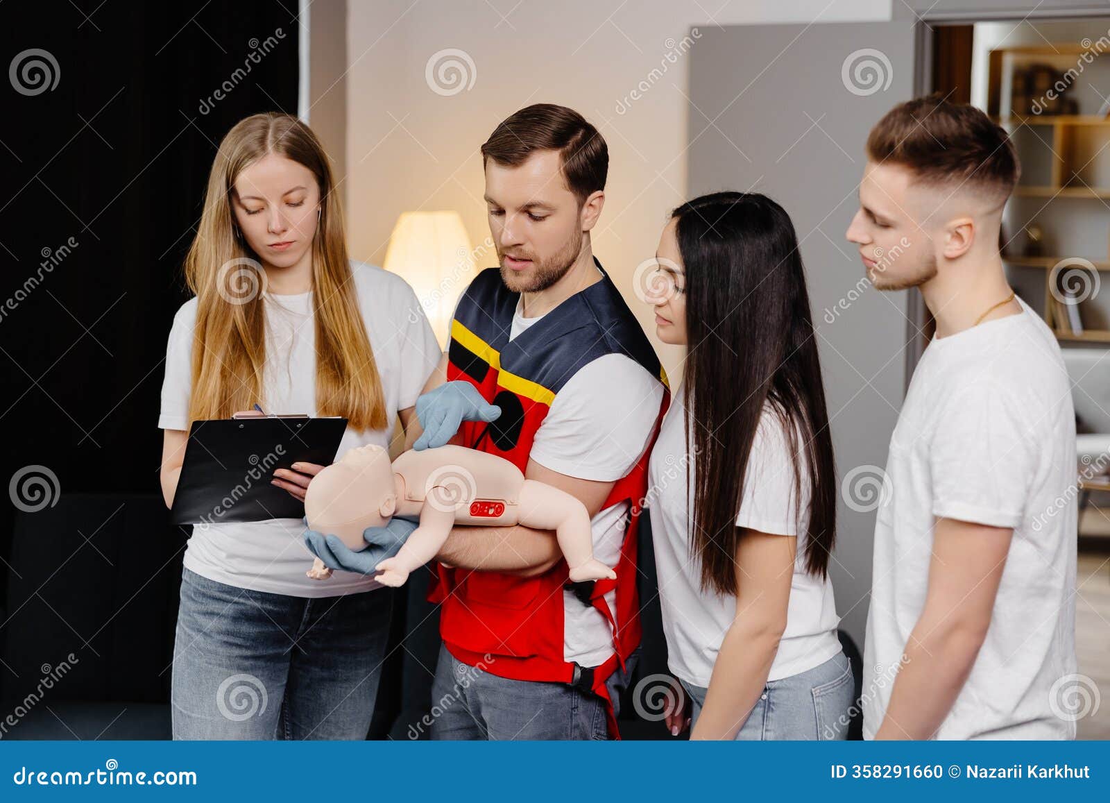 Group of People Learning How To Make First Aid with Dummy Child during ...