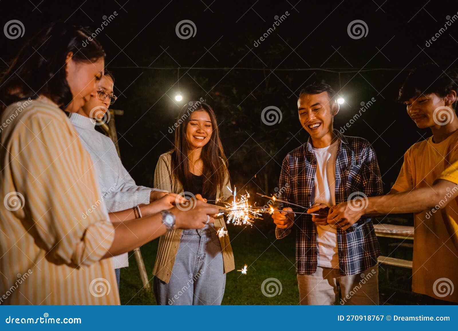 A Group of People Playing with the Fireworks Happily while Camping ...