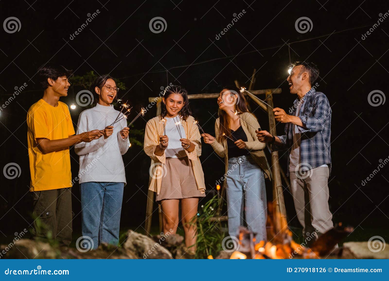 A Group of People Playing with the Fireworks Happily at the Night Stock ...