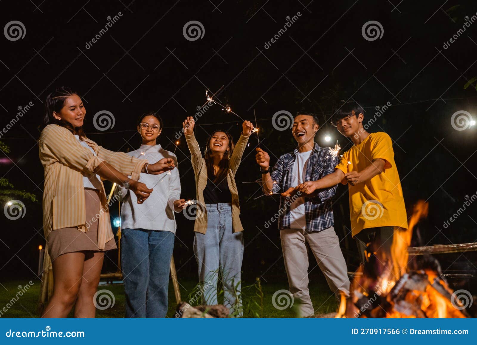 A Group of People Playing the Fireworks Happily Stock Photo - Image of ...