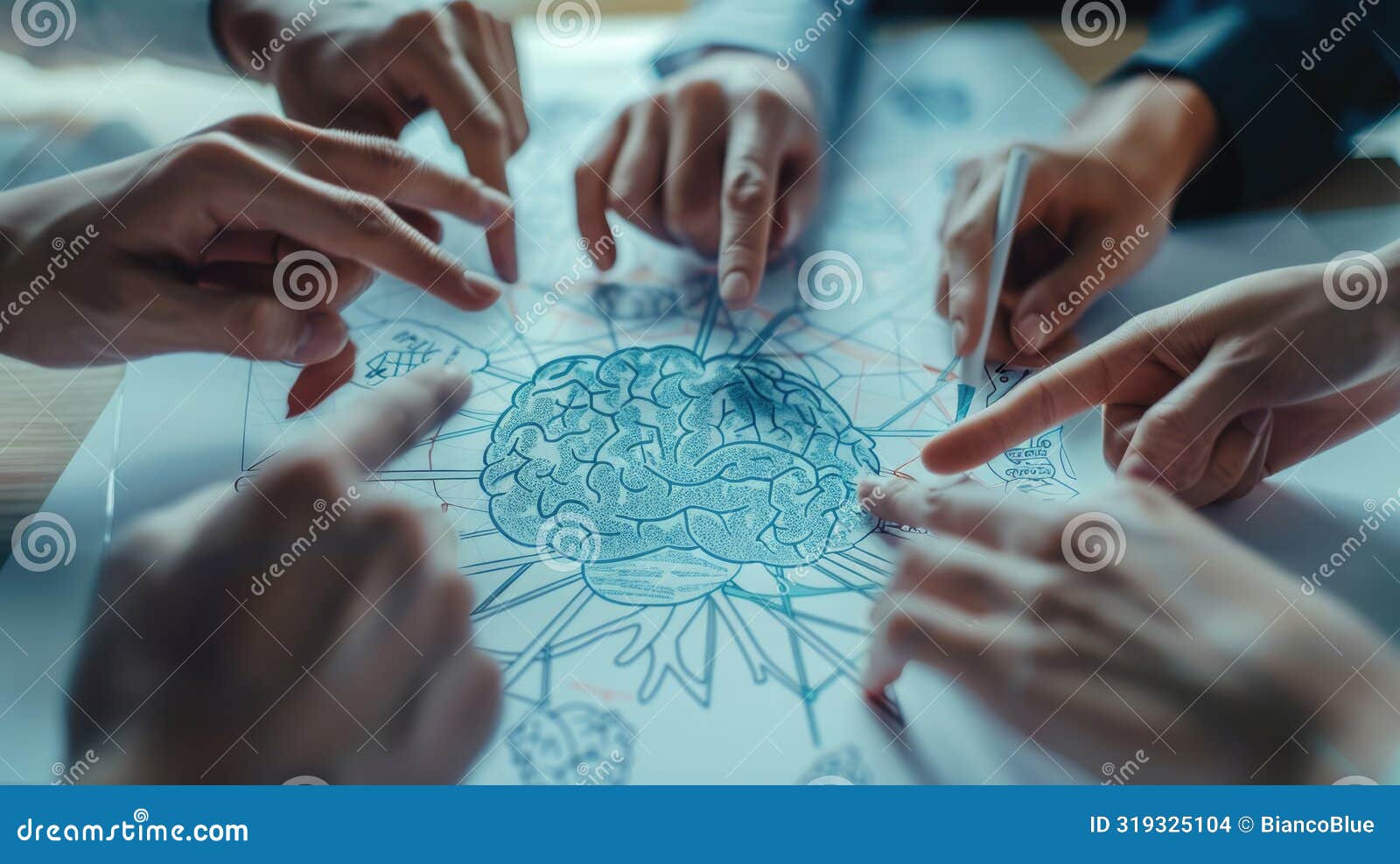 A Group of People are Pointing at a Brain-shaped Image on a Table the ...