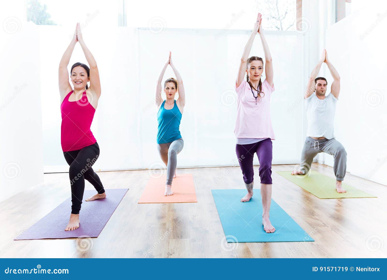Group of People Practicing Yoga at Home. Virabhadrasana Pose Stock ...
