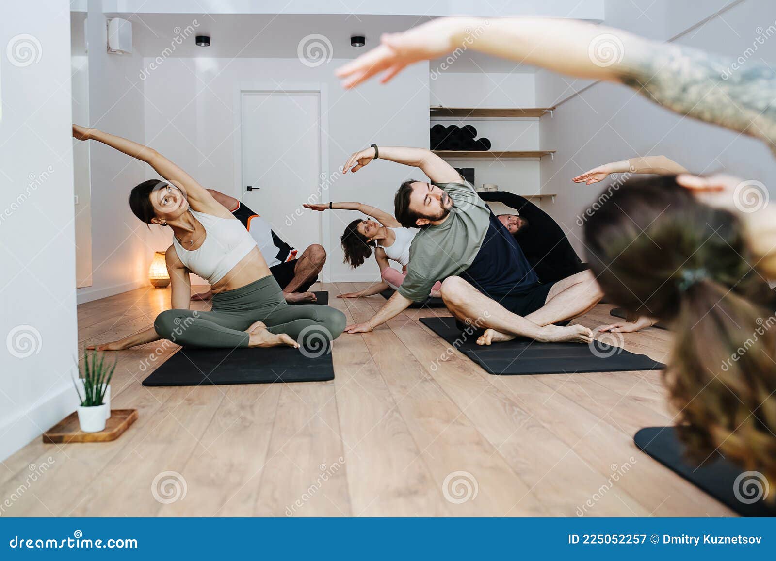 Group of People Practicing Yoga, Side Bending in Easy Pose Stock Image ...