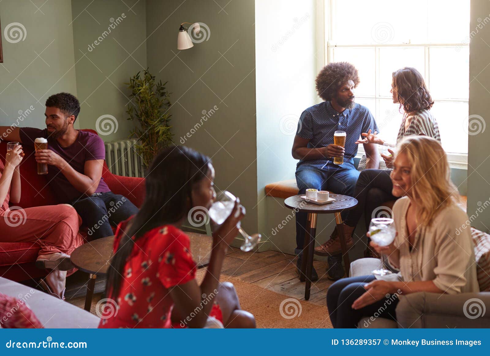 A Group of People in a Pub Drinking and Talking Stock Image - Image of ...