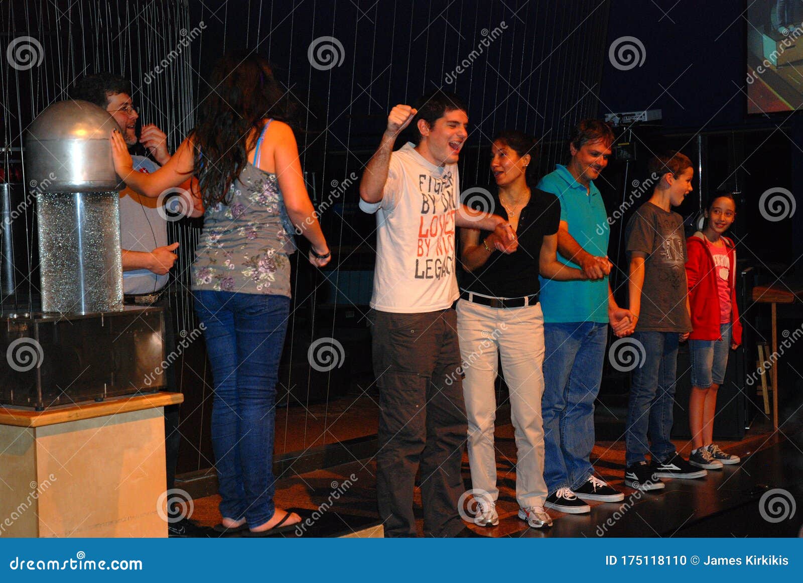 A Group of People Receive a Shock in an Electricity Demonstration ...