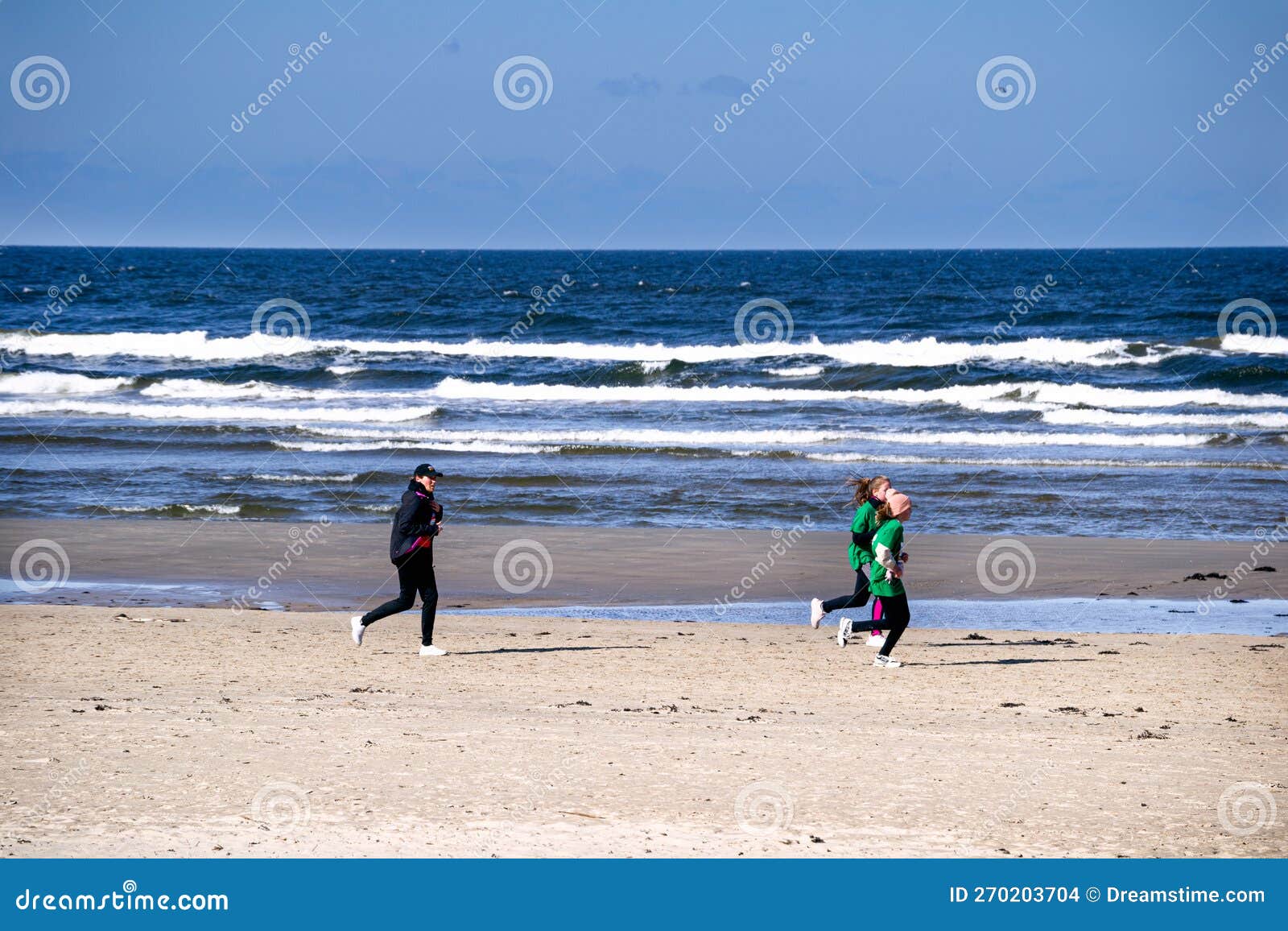 A Group of People Runs a Marathon on the Beach by the Sea Editorial ...
