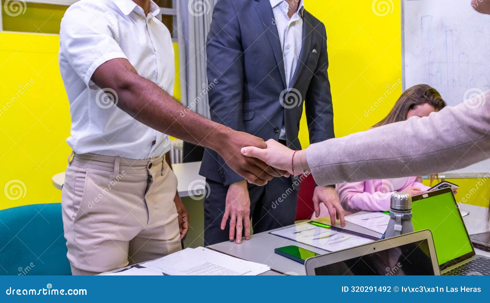 A Group of People Shaking Hands in a Business Setting Stock Photo ...