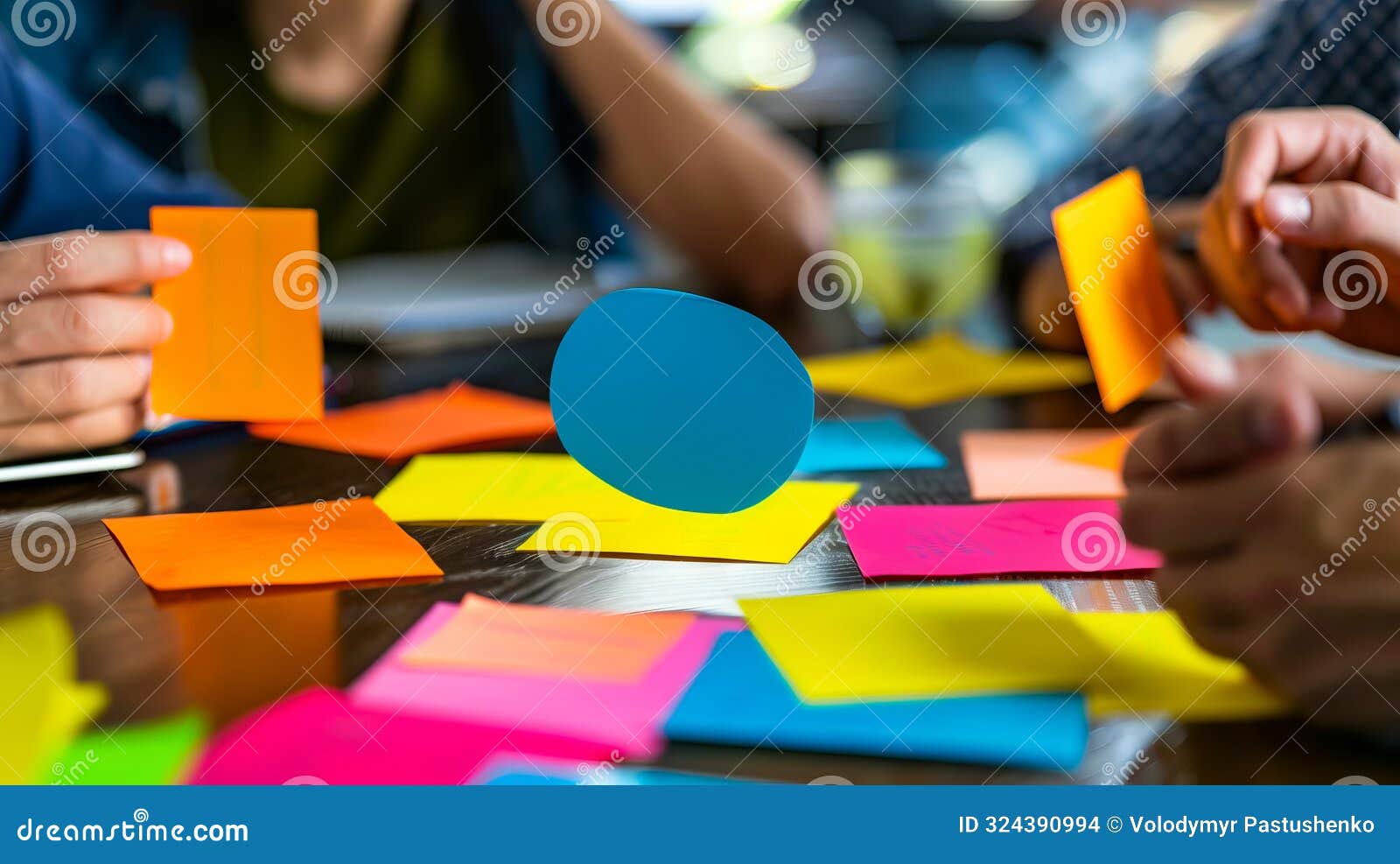 A Group of People Sitting Around a Table with Sticky Notes Stock ...