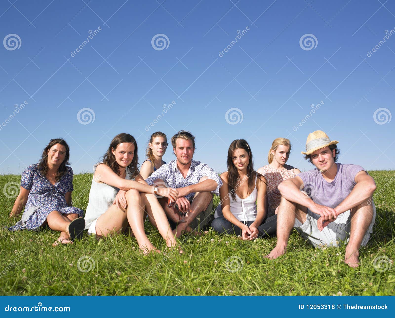 Group of People Sitting on the Grass Stock Photo - Image of attractive ...