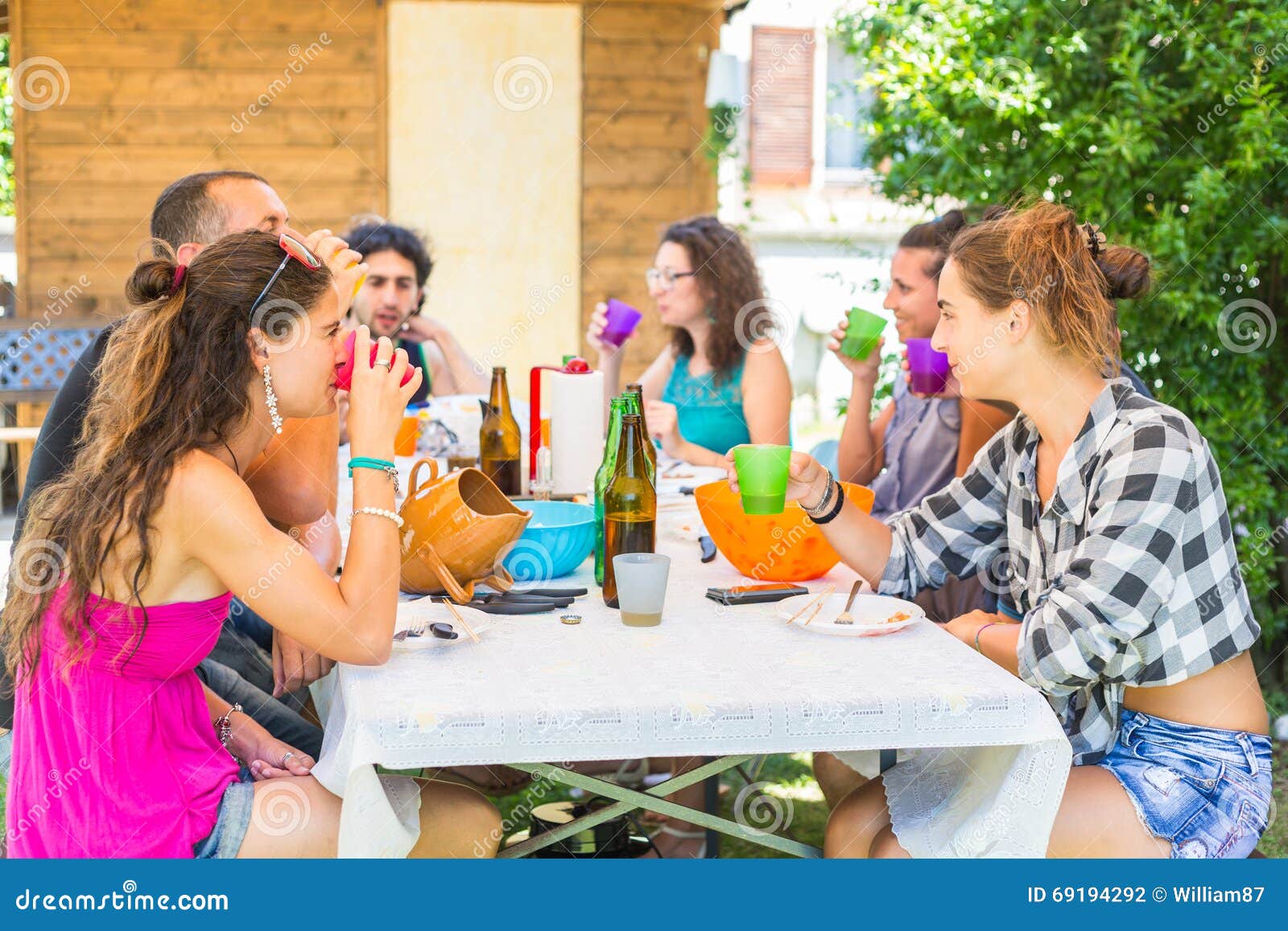Group of People Sitting Having Lunch Together and Drinking Stock Photo ...
