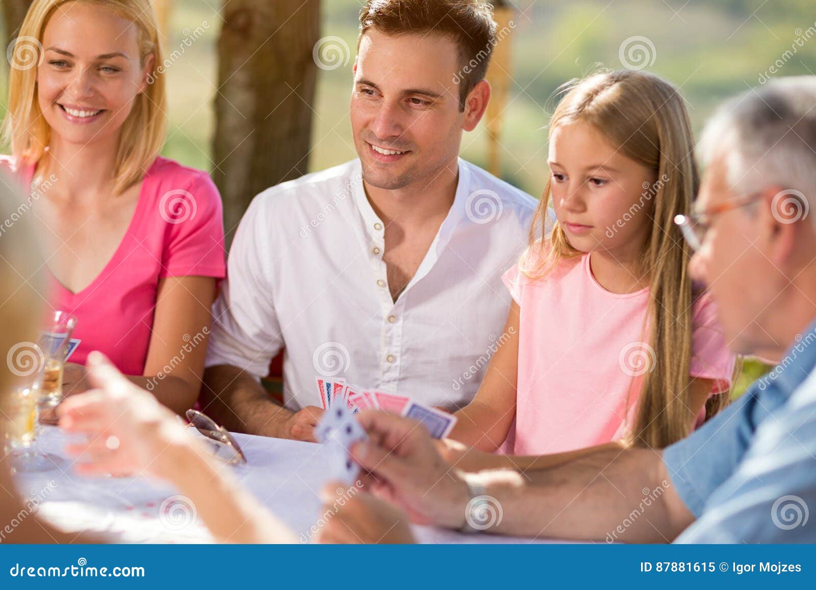 Group of People Sitting and Playing Cards Stock Image - Image of ...