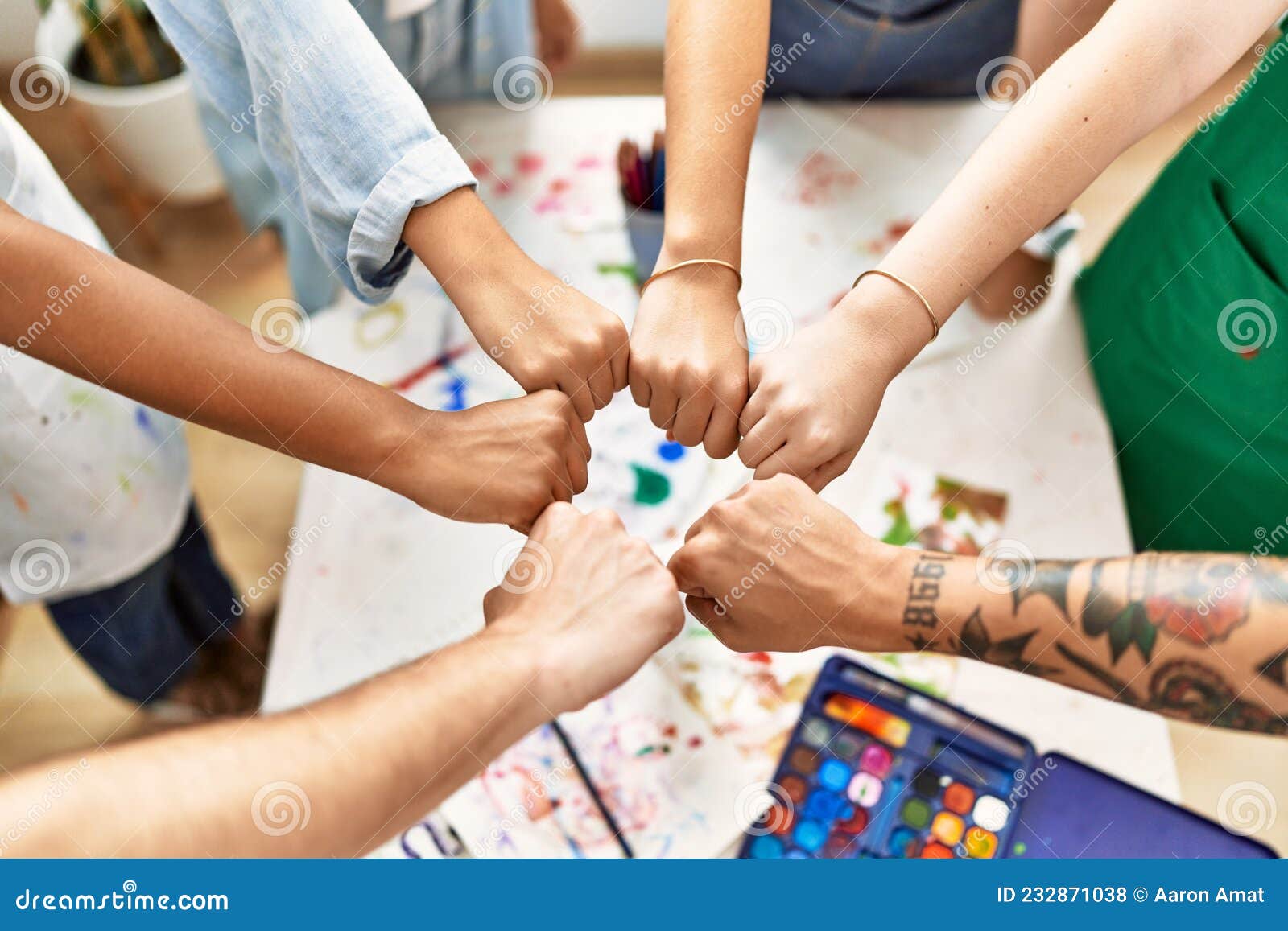 Group of People Sitting on the Table Bump Fists at Art Studio Stock ...