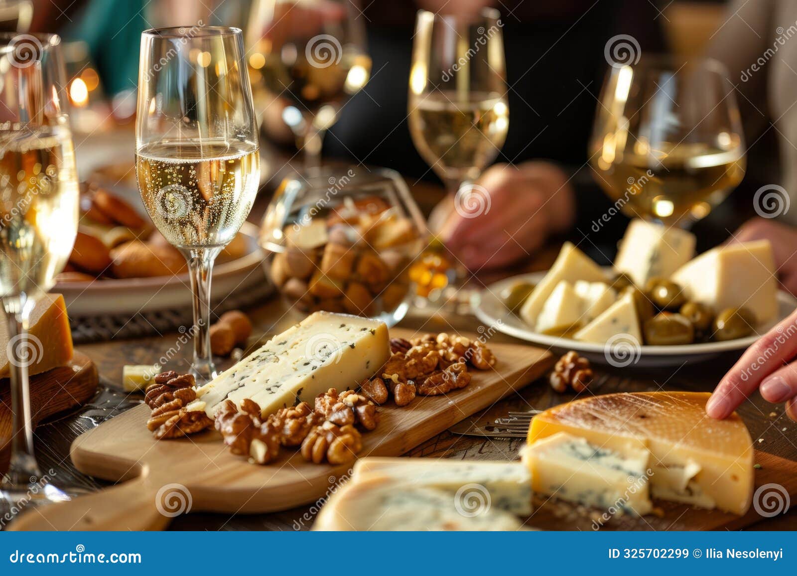 A Group of People Sitting at a Table, Enjoying Wine and Cheese Together ...