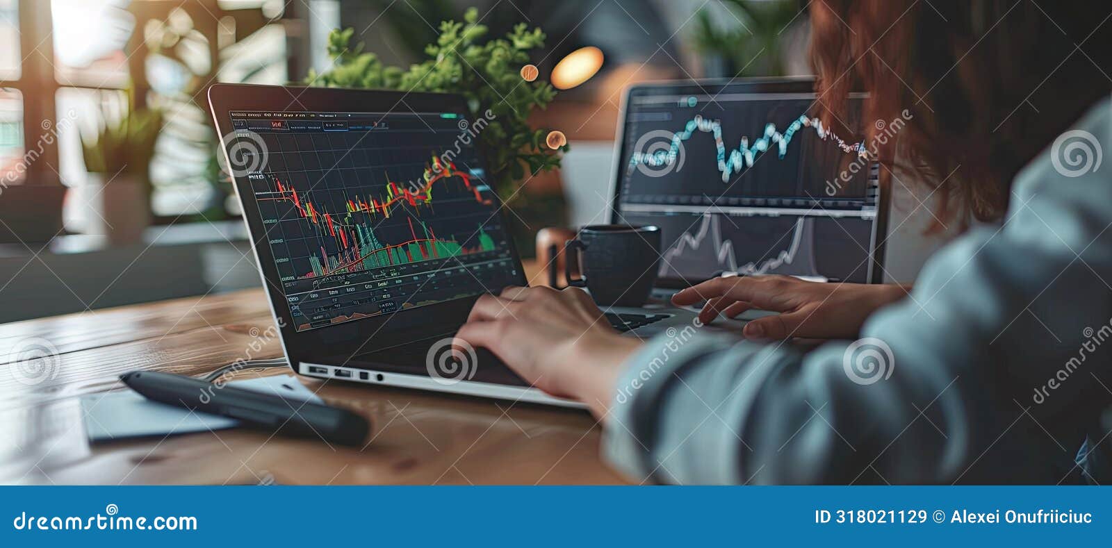 A Group of People are Sitting at a Table Looking at a Laptop Computer ...