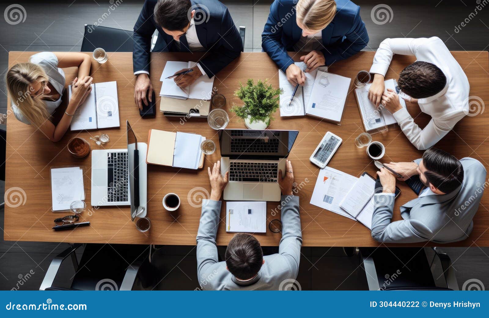 A Group of People Sitting at a Table Working on Laptops Stock ... A Group of People Sitting at a Table Working on Laptops Stock ...