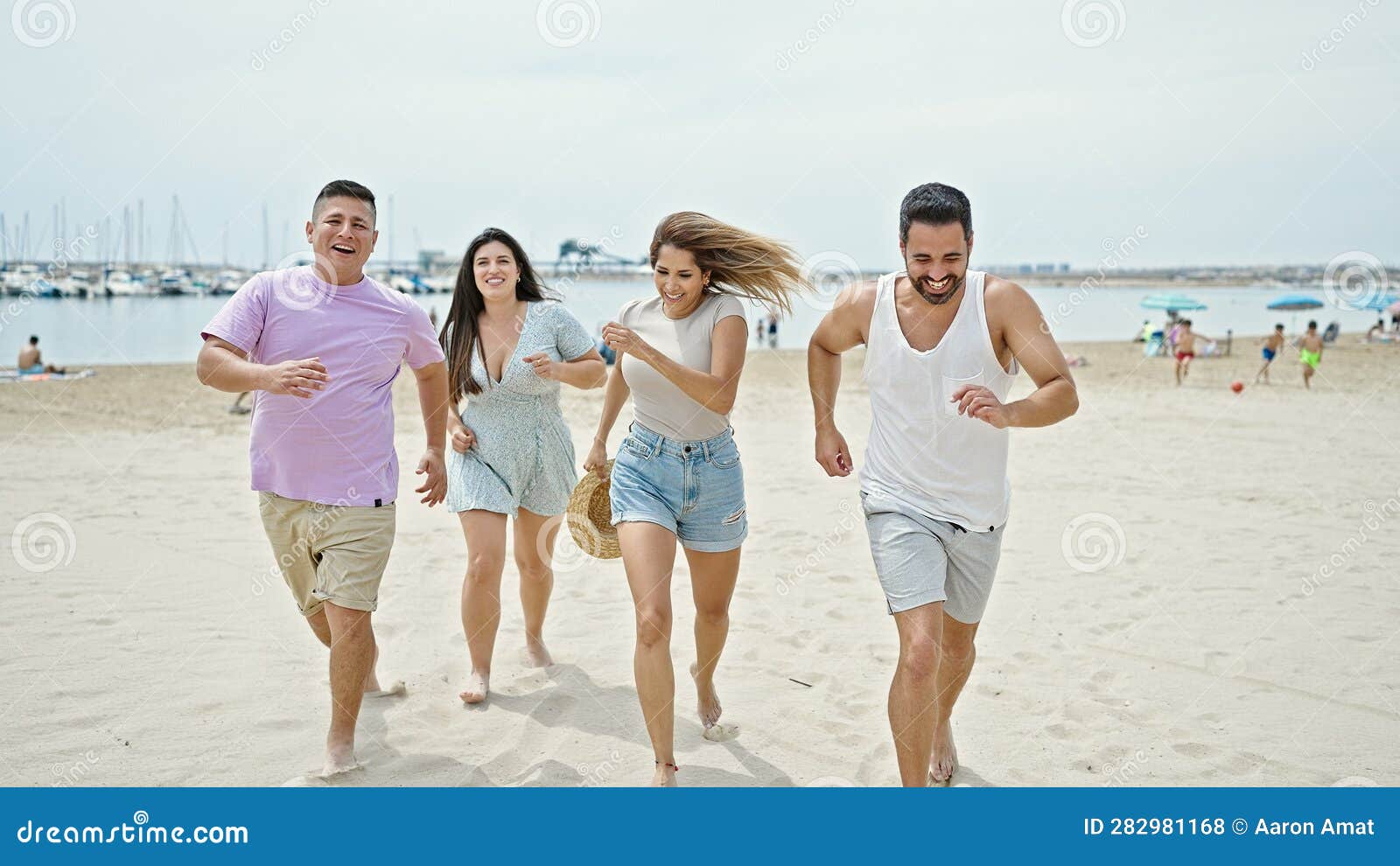 Group of People Smiling Confident Running at Beach Stock Photo - Image ...