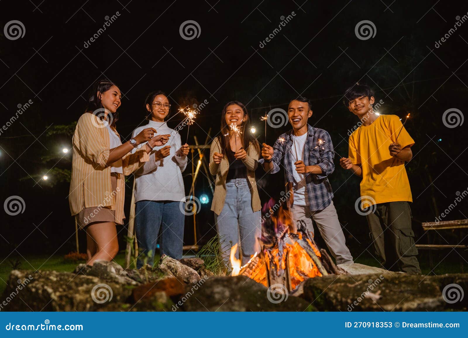 A Group of People Smiling while Playing the Fireworks Stock Image ...