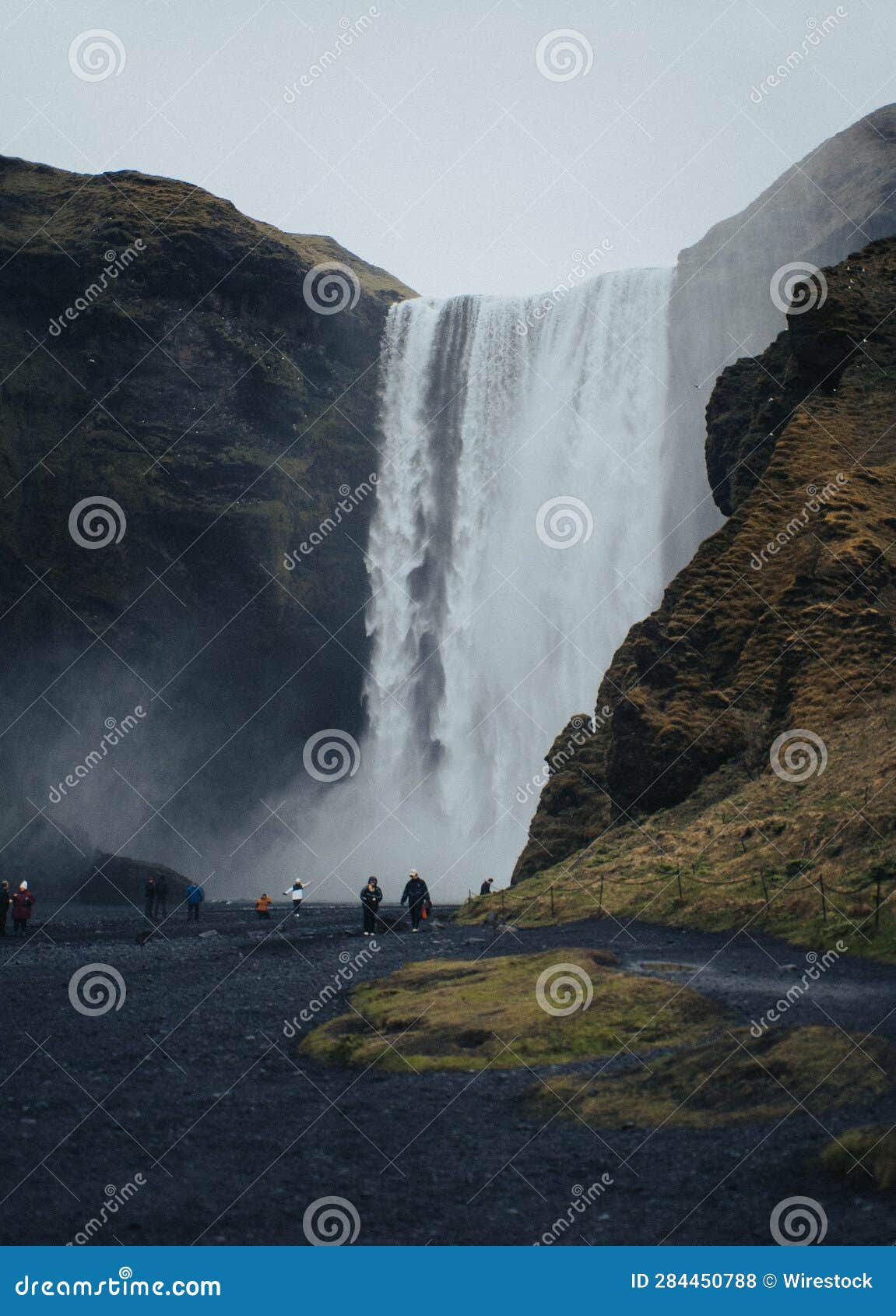 Group of People Standing in Awe of a Powerful Waterfall Stock Photo ...